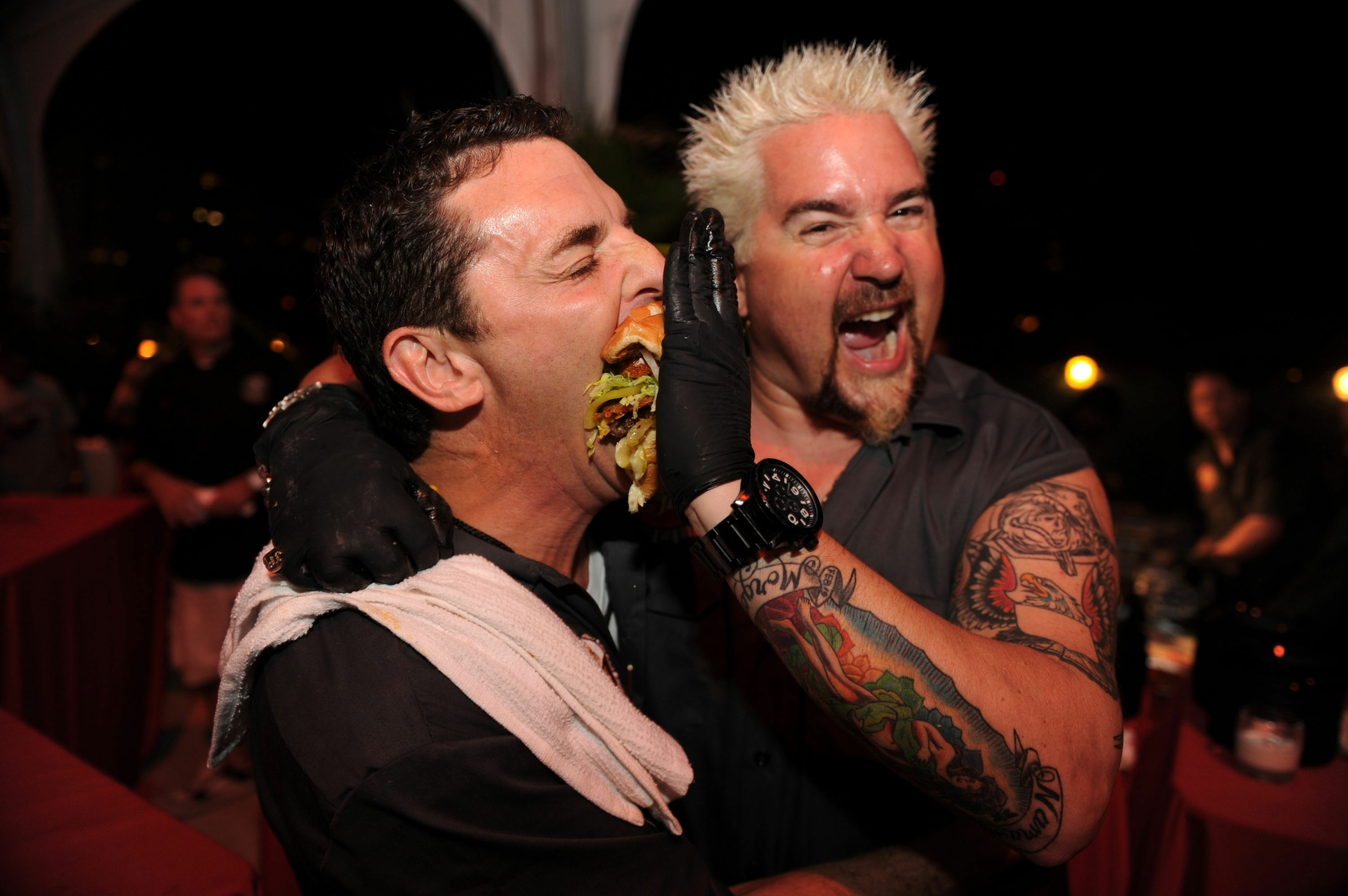 Photo | Guy Fieri gently feeds Carnival Cruise Lines' Senior Vice ...