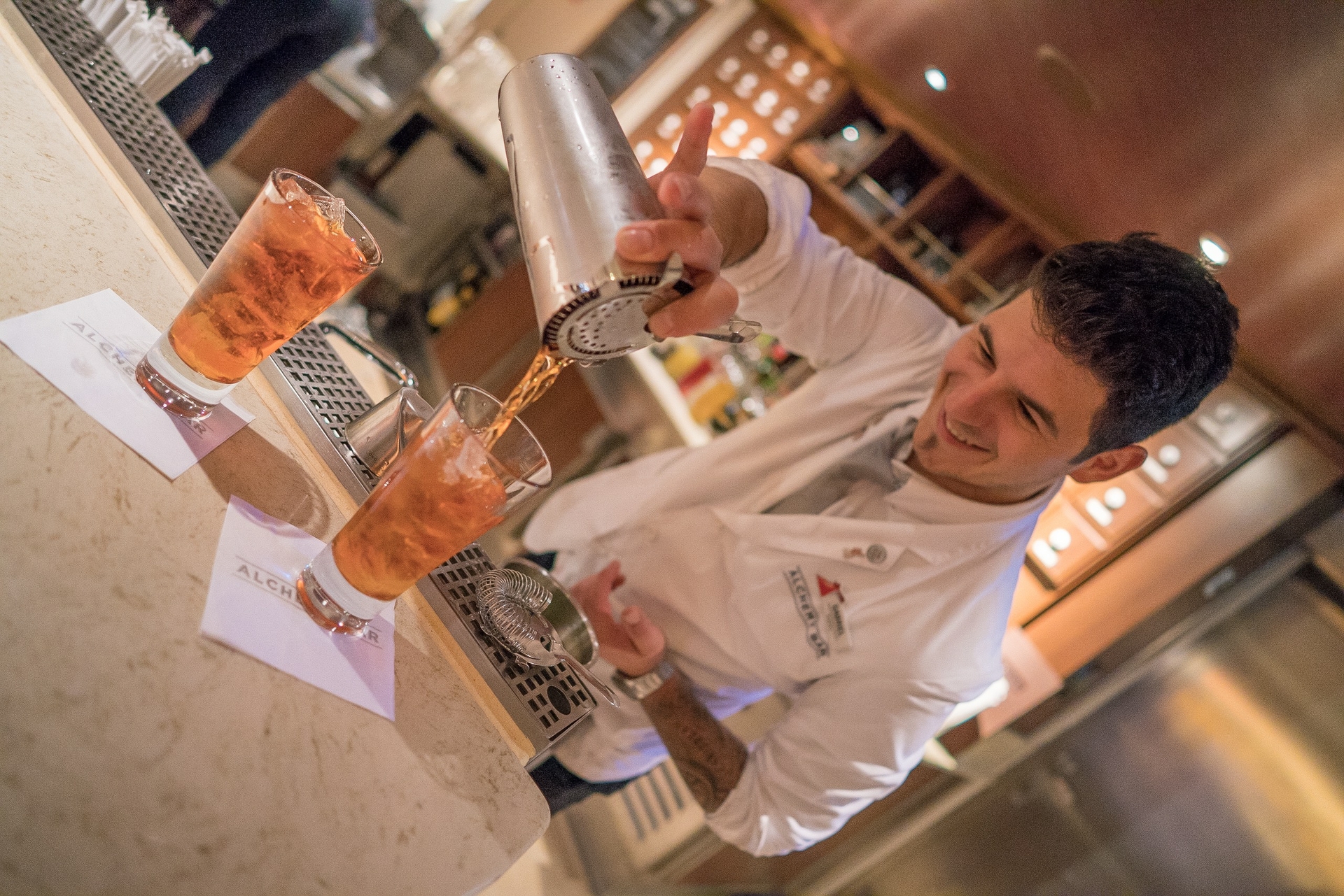 Photo | Mixologist pours drinks at Alchemy Bar | Carnival Cruise Line