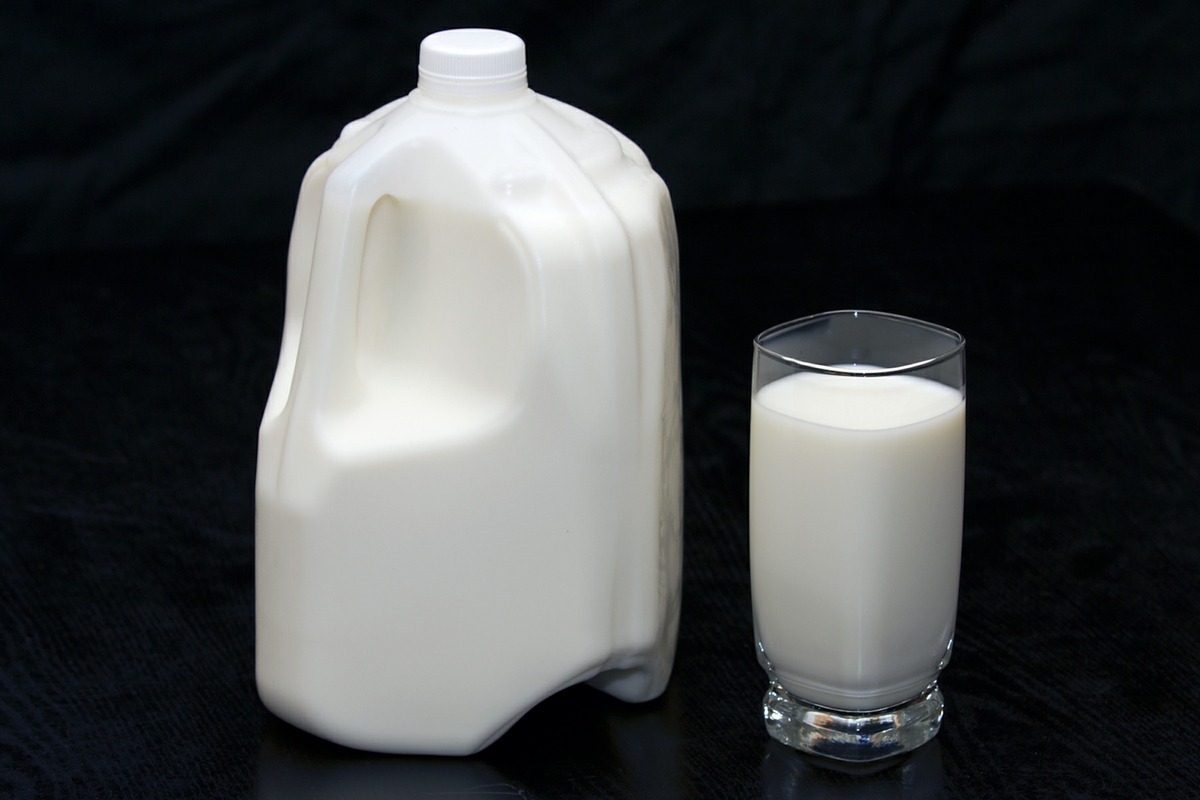 Photo Milk LowFat In Glass With Full Jug Horizontal From Above
