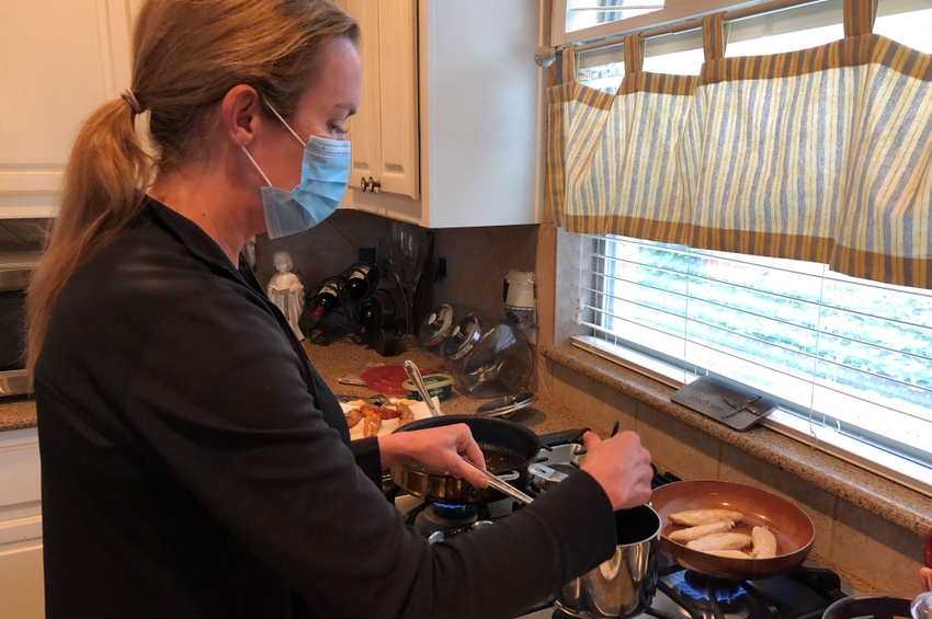 Photo | Woman wearing a mask while cooking | American Heart Association