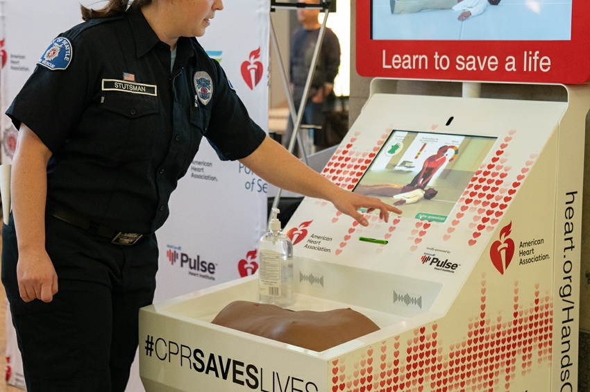 Photo | Seattle firefighter demonstrates how to use a CPR kiosk ...