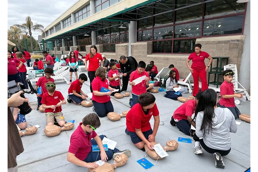 Photo | Hands-Only CPR practice at swim safety event | American Heart ...