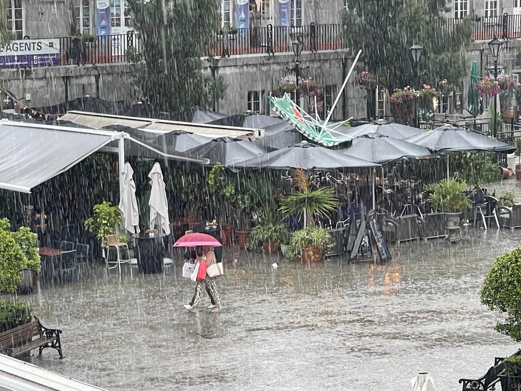 Torrential rain floods businesses and roads