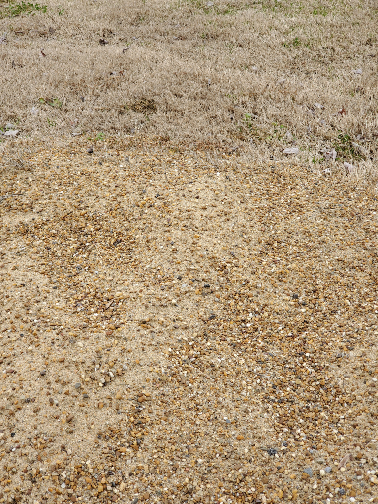 Driving range hitting area top dressed with river bottom sand with ...