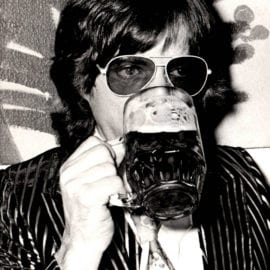 Mick Jagger drinking beer from a mug in Germany - Holden Luntz Gallery