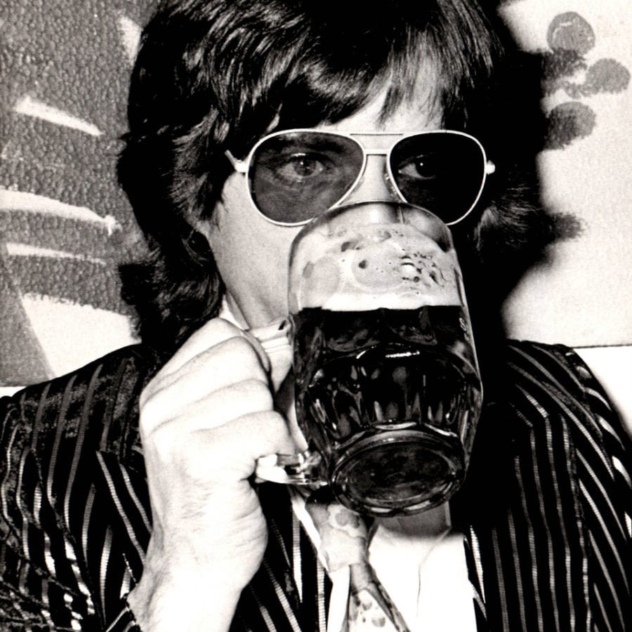 Mick Jagger drinking beer from a mug in Germany - Holden Luntz Gallery