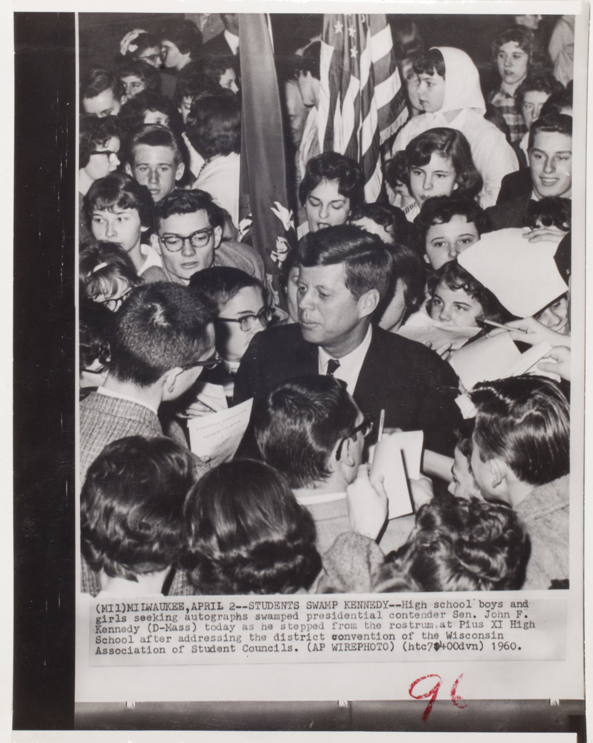 [John F. Kennedy surrounded by high school students seeking autographs ...
