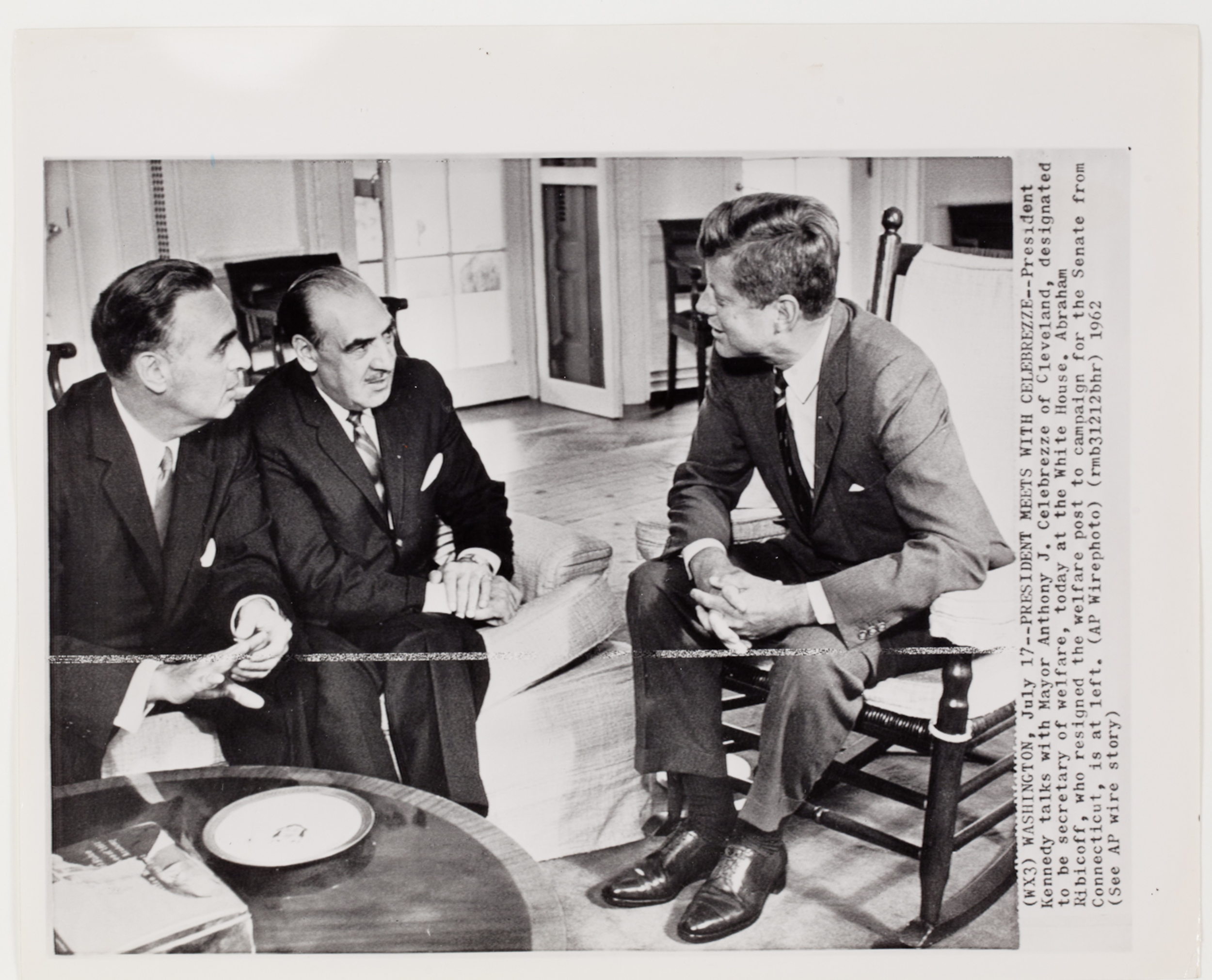 [President John F. Kennedy sitting in a rocking chair talking to the ...