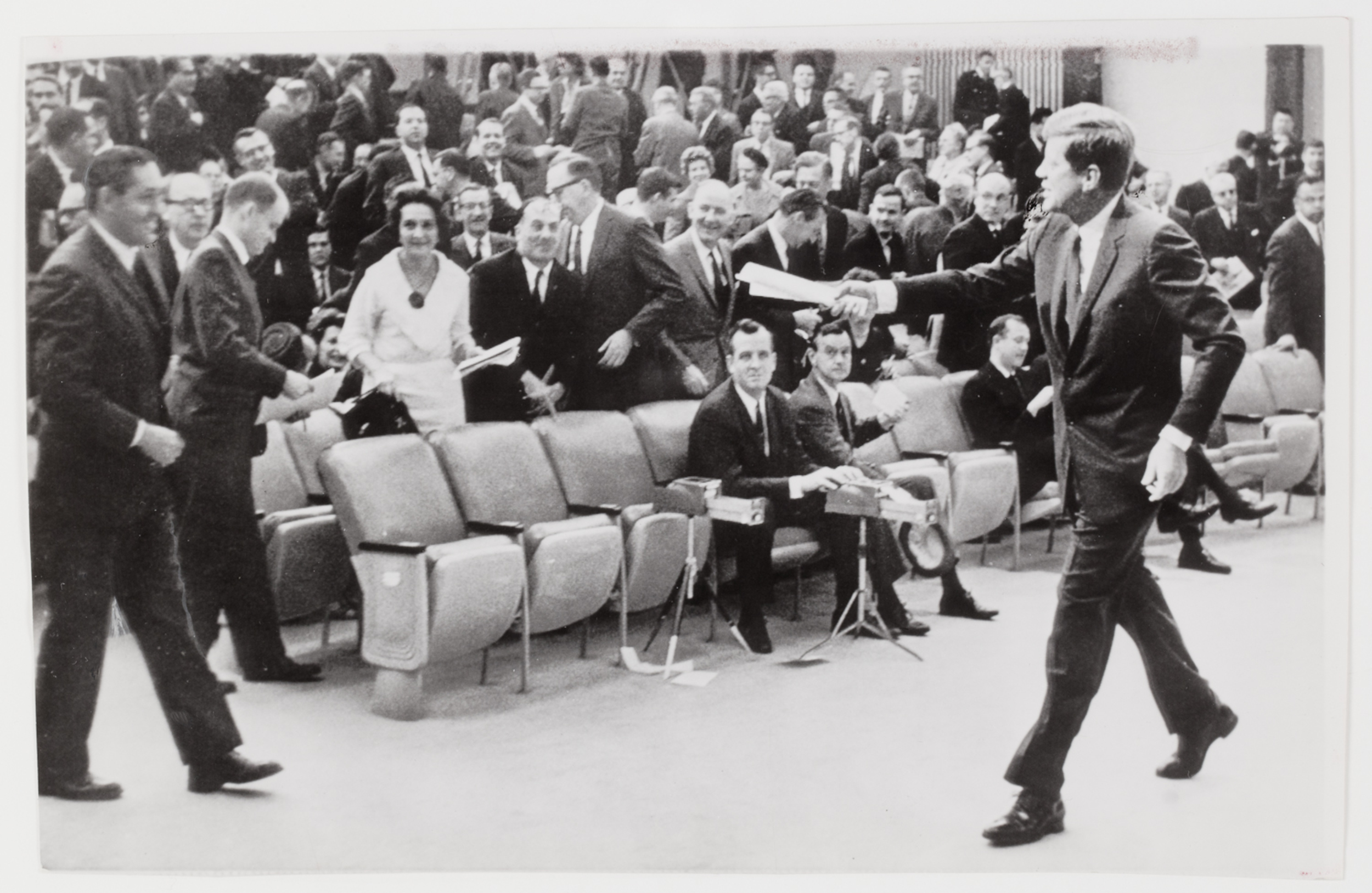 [President John F. Kennedy leaving the auditorium after a press ...
