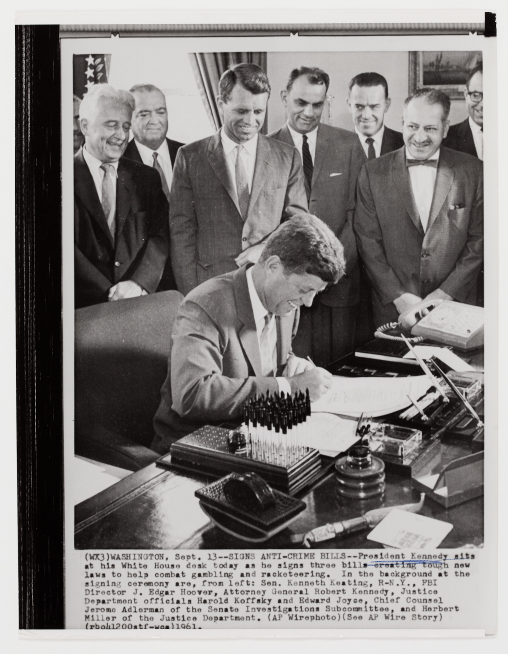 [President John F. Kennedy signing new bills in front of J. Edgar ...