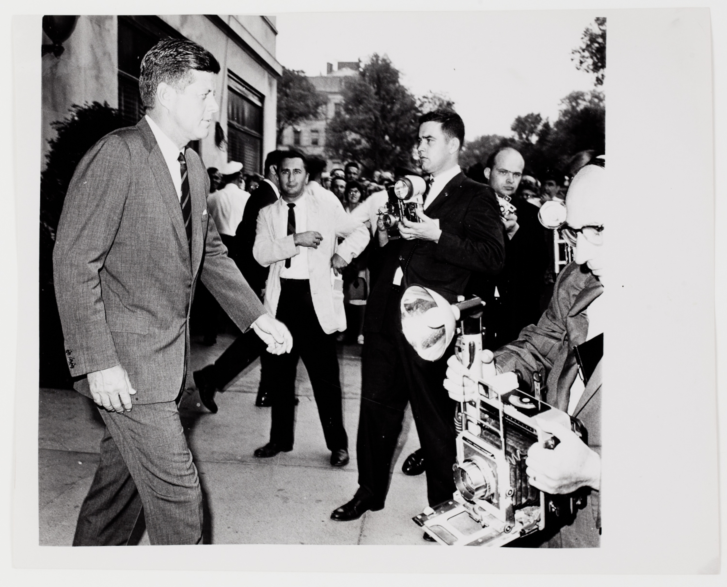 [President John F. Kennedy surrounded by reporters outside the Ritz ...