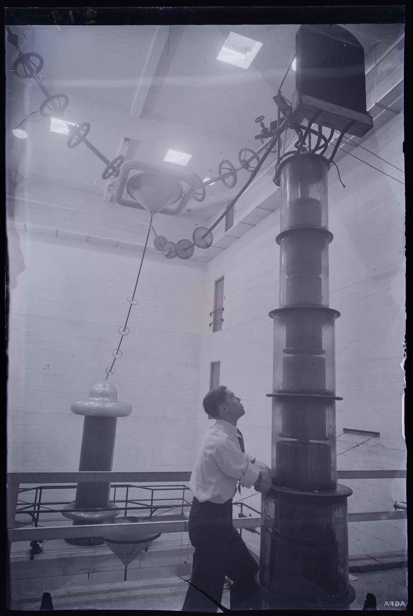[Man looking at machine] | International Center of Photography