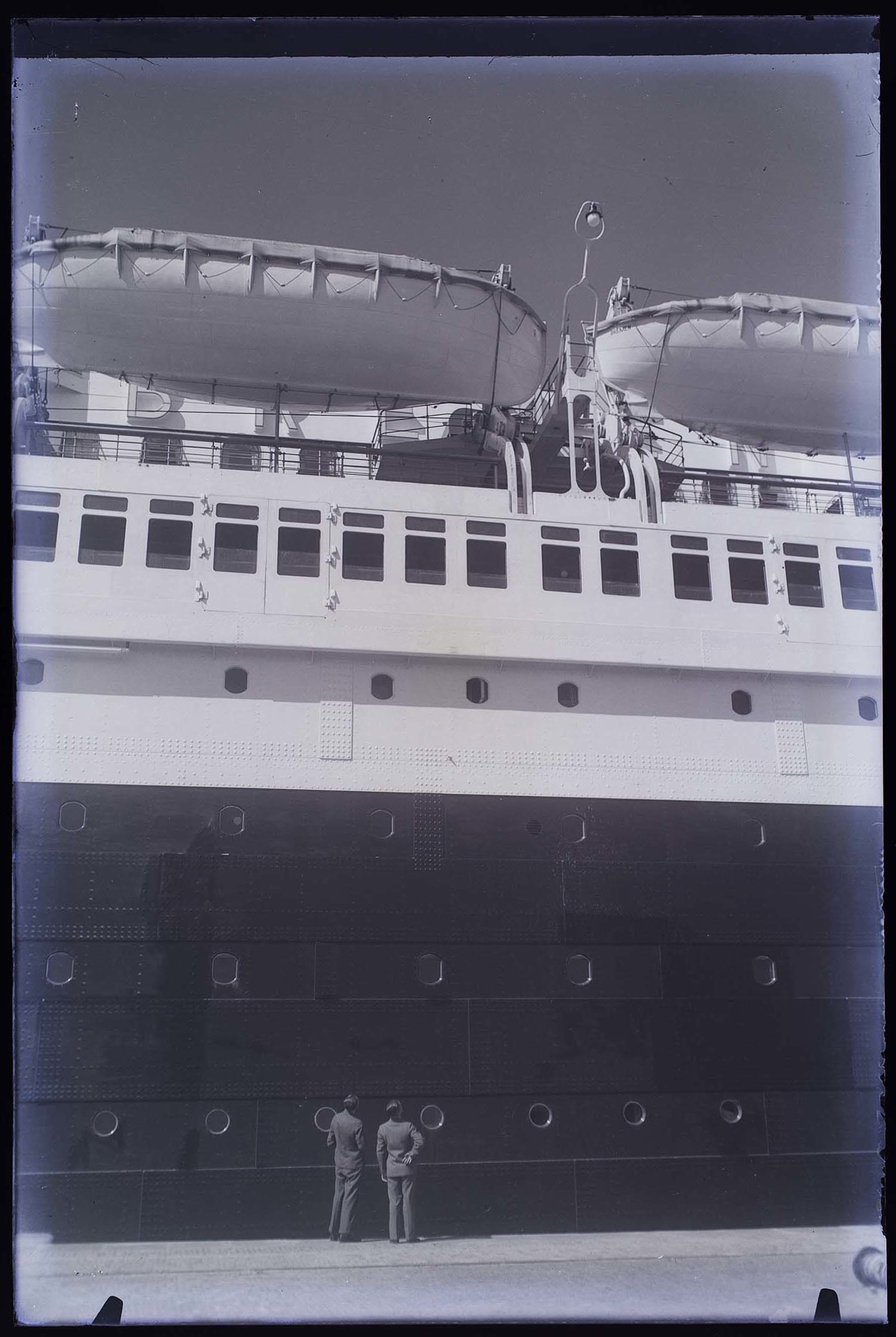 [Men looking at lifeboats on SS Bremen] | International Center of ...