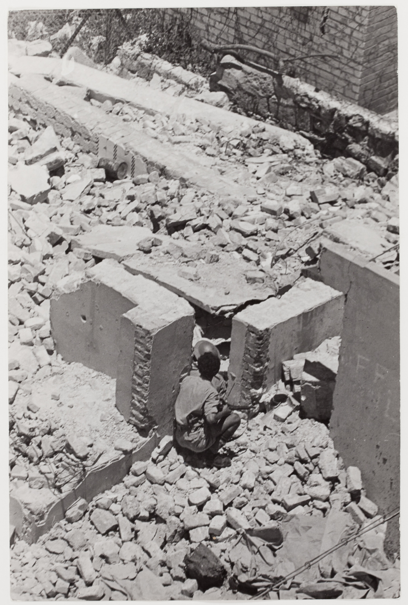 [Troops sitting in rubble, Israel] | International Center of Photography