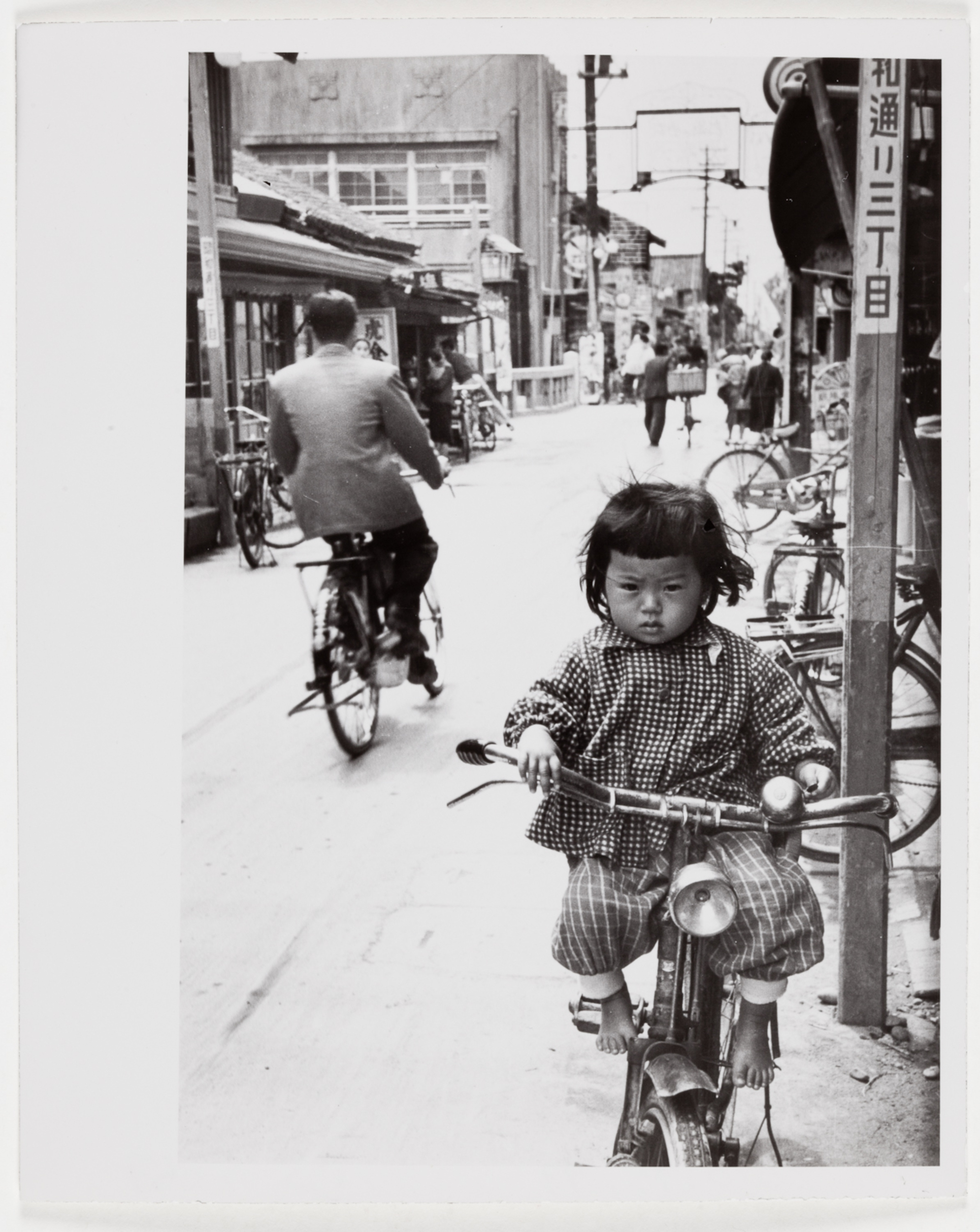 [Child riding a bicycle in the street, Japan] | International Center of ...