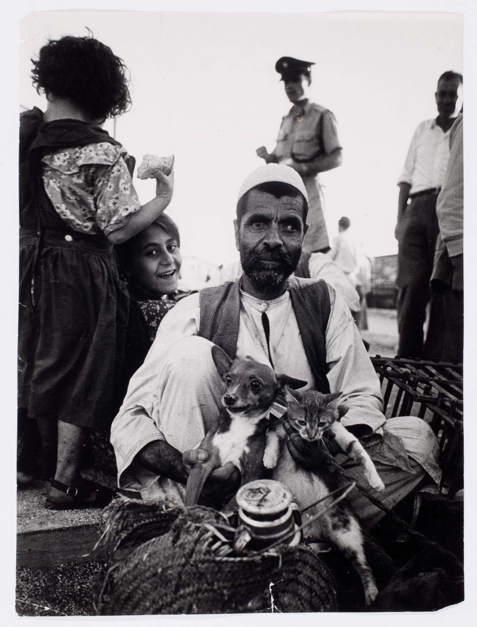 [Libyan man holding a dog and cat at Shaar Alyjah transit camp, Israel ...