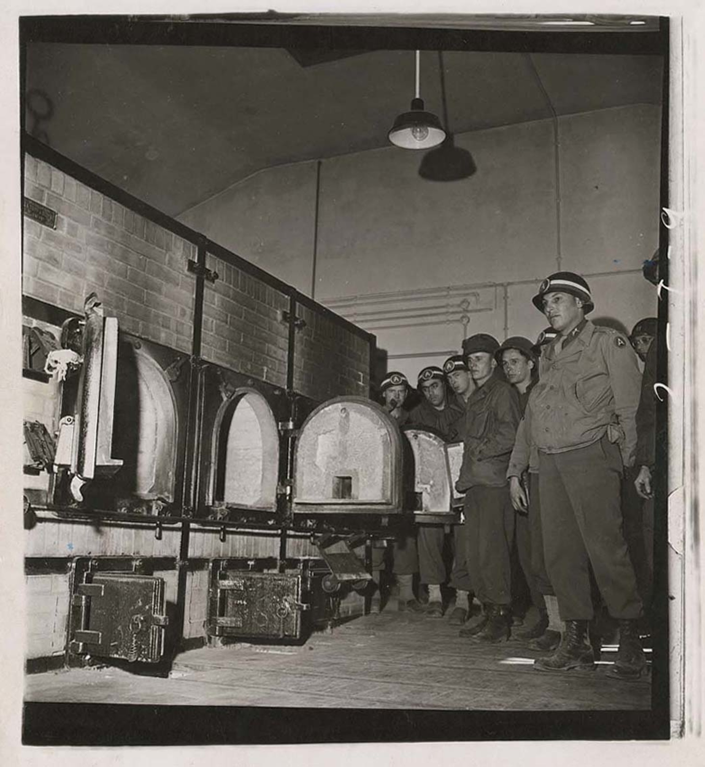 BUCHENWALD: American soldiers look at a row of incinerators ...