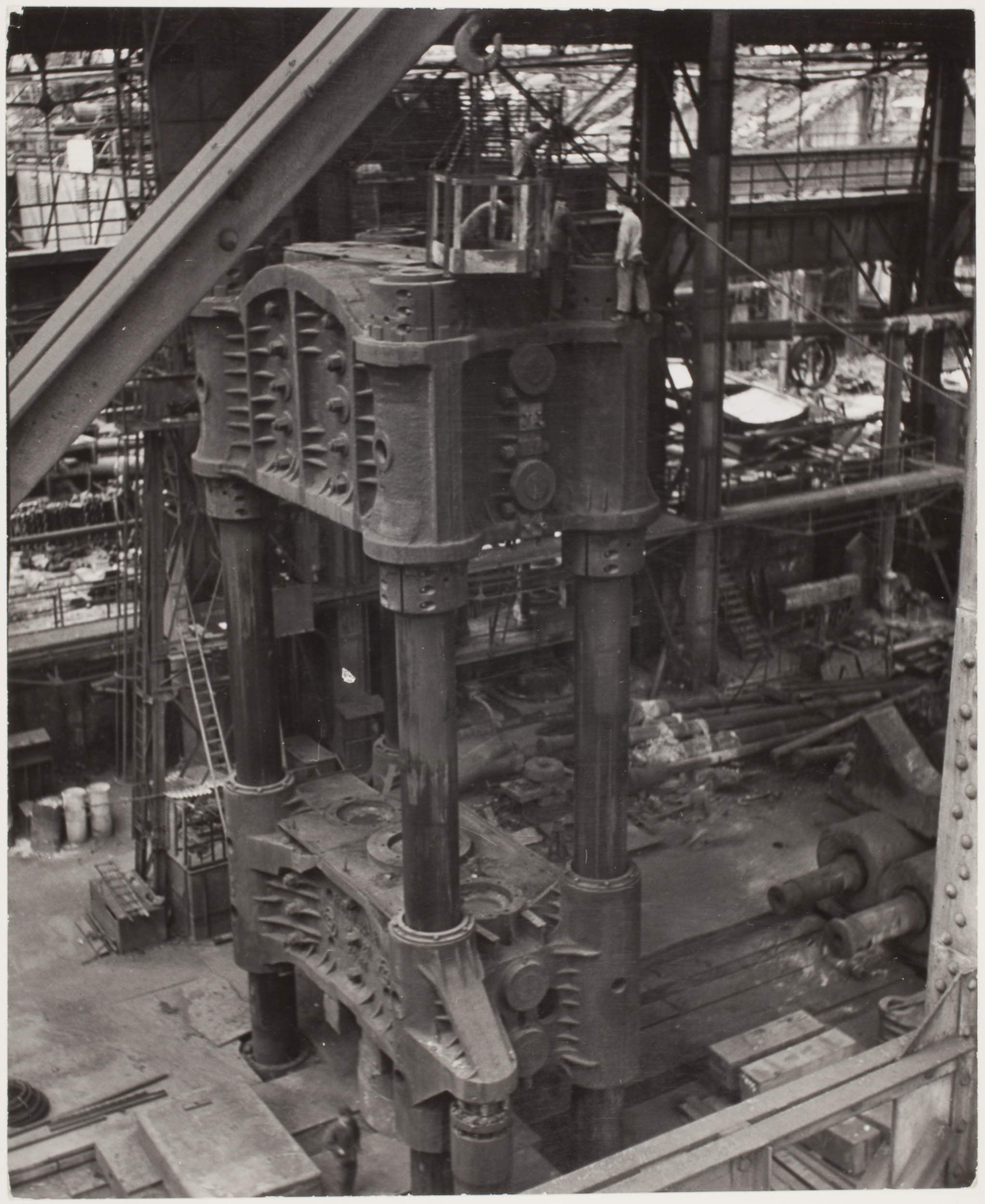 [Men standing on giant steel press, Krupp steelworks, Ruhr region ...