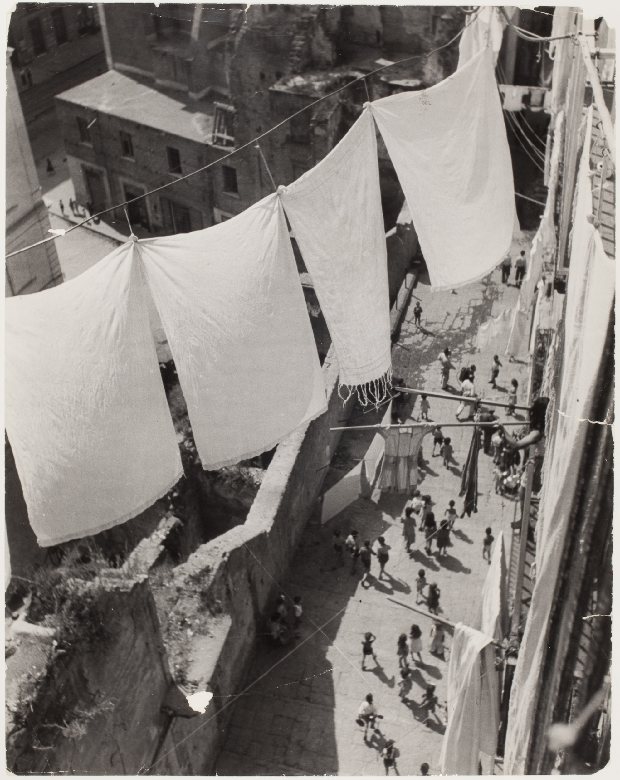 [Street scene below hanging laundry, Naples] | International Center of ...