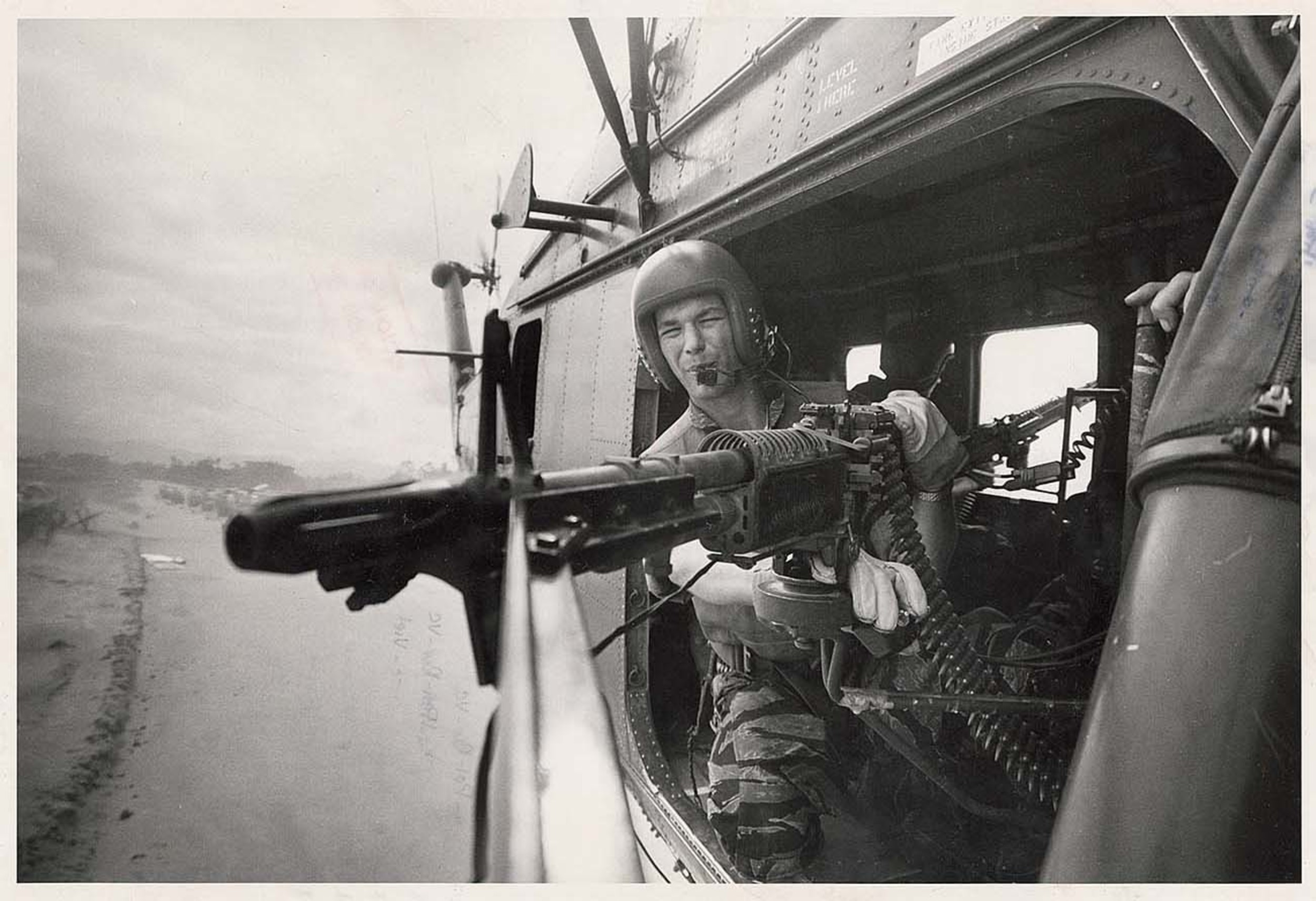 [Crew chief Lance Cpl. James C. Farley manning helicopter machine gun ...