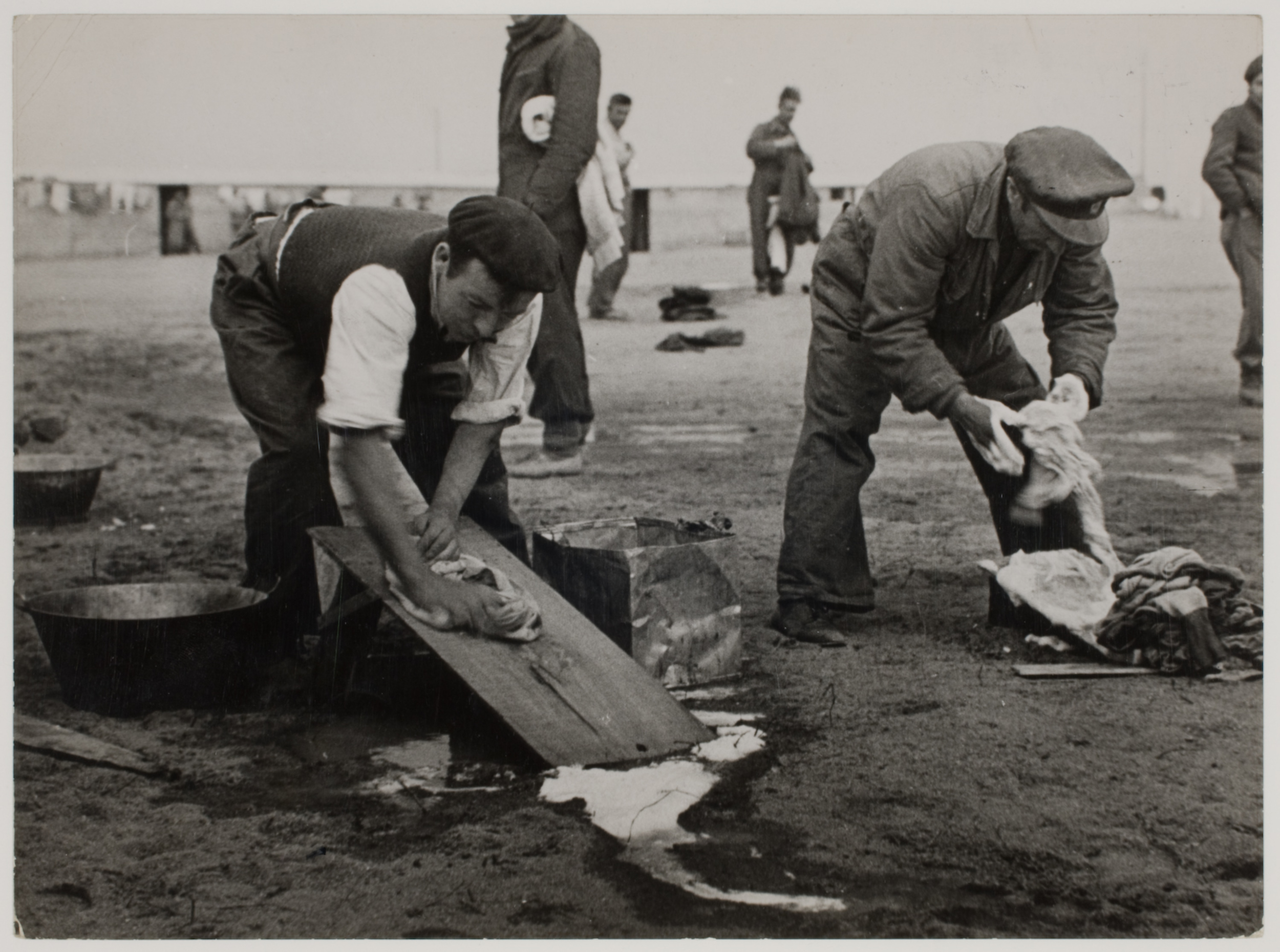 [Two men wash clothes at a concentration camp for Spanish refugees ...