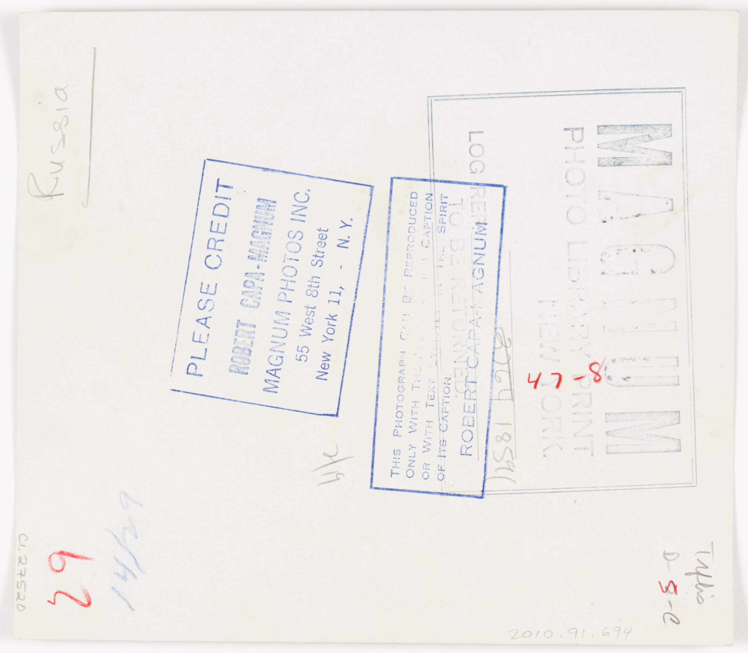 [Farmer weighing cabbage on a scale in front of customers at an outdoor ...