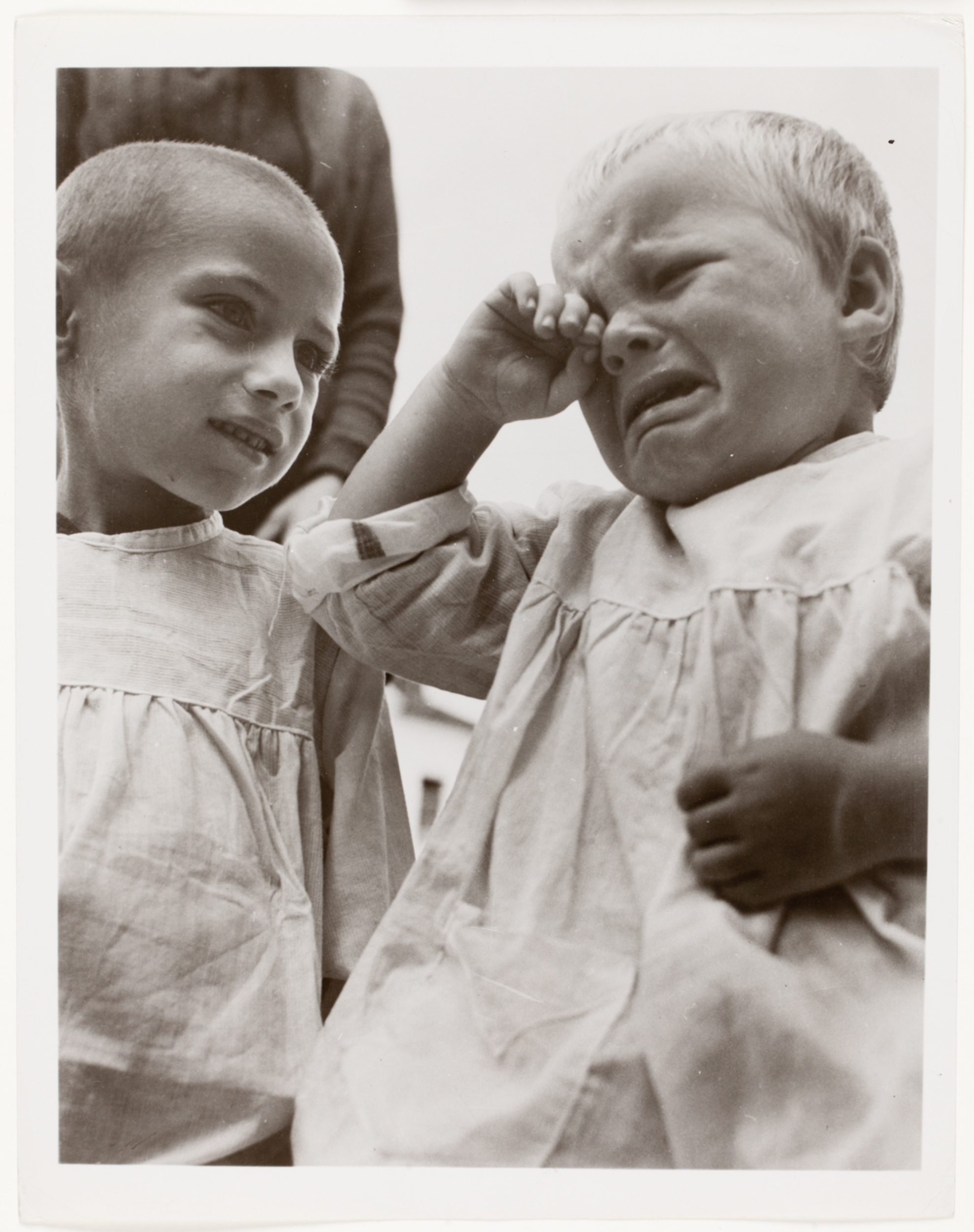 [One child of an orphanage crying with another child standing close to ...