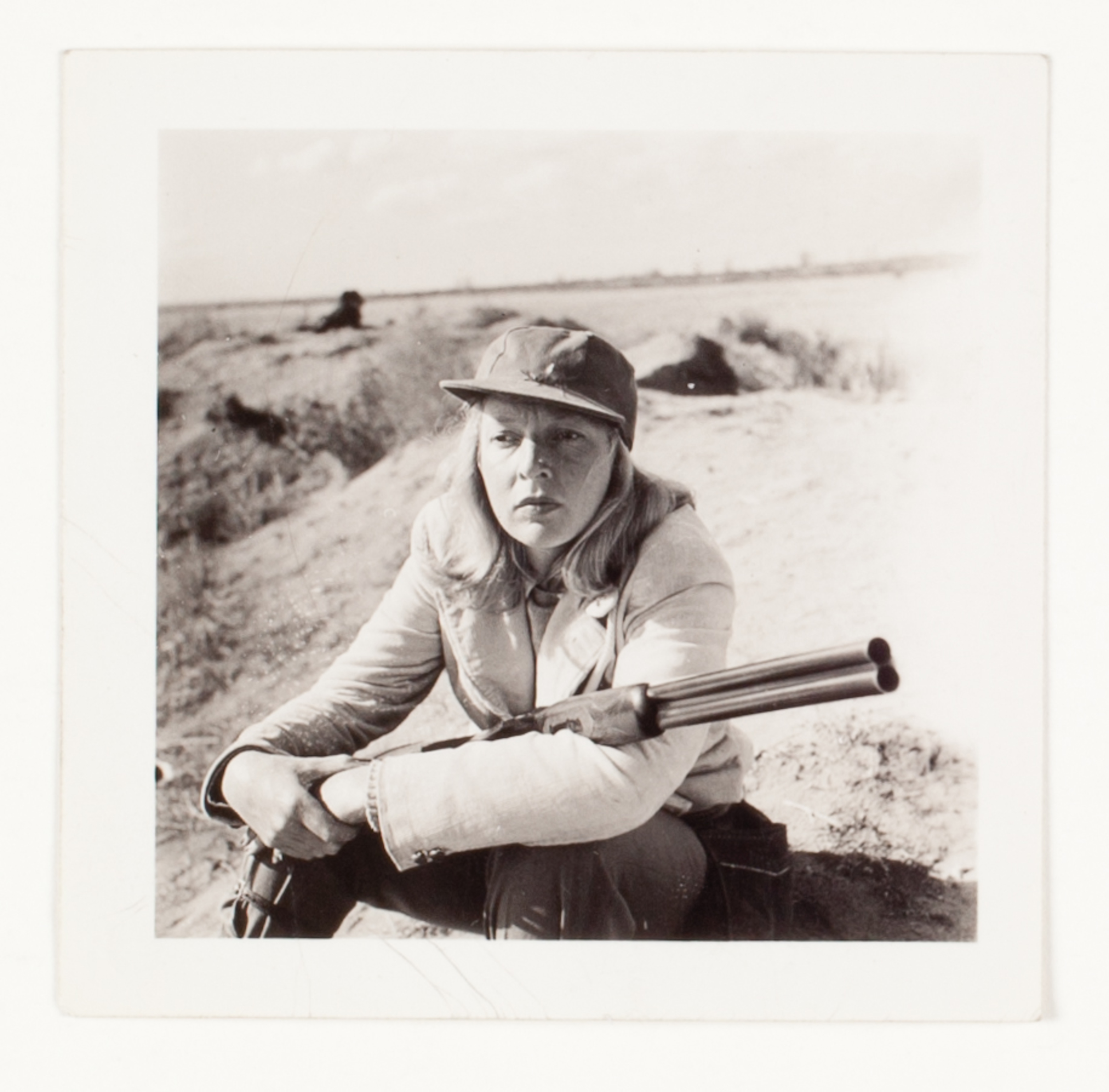 [Martha Gellhorn sitting with a rifle in her arms, Sun Valley, Idaho ...