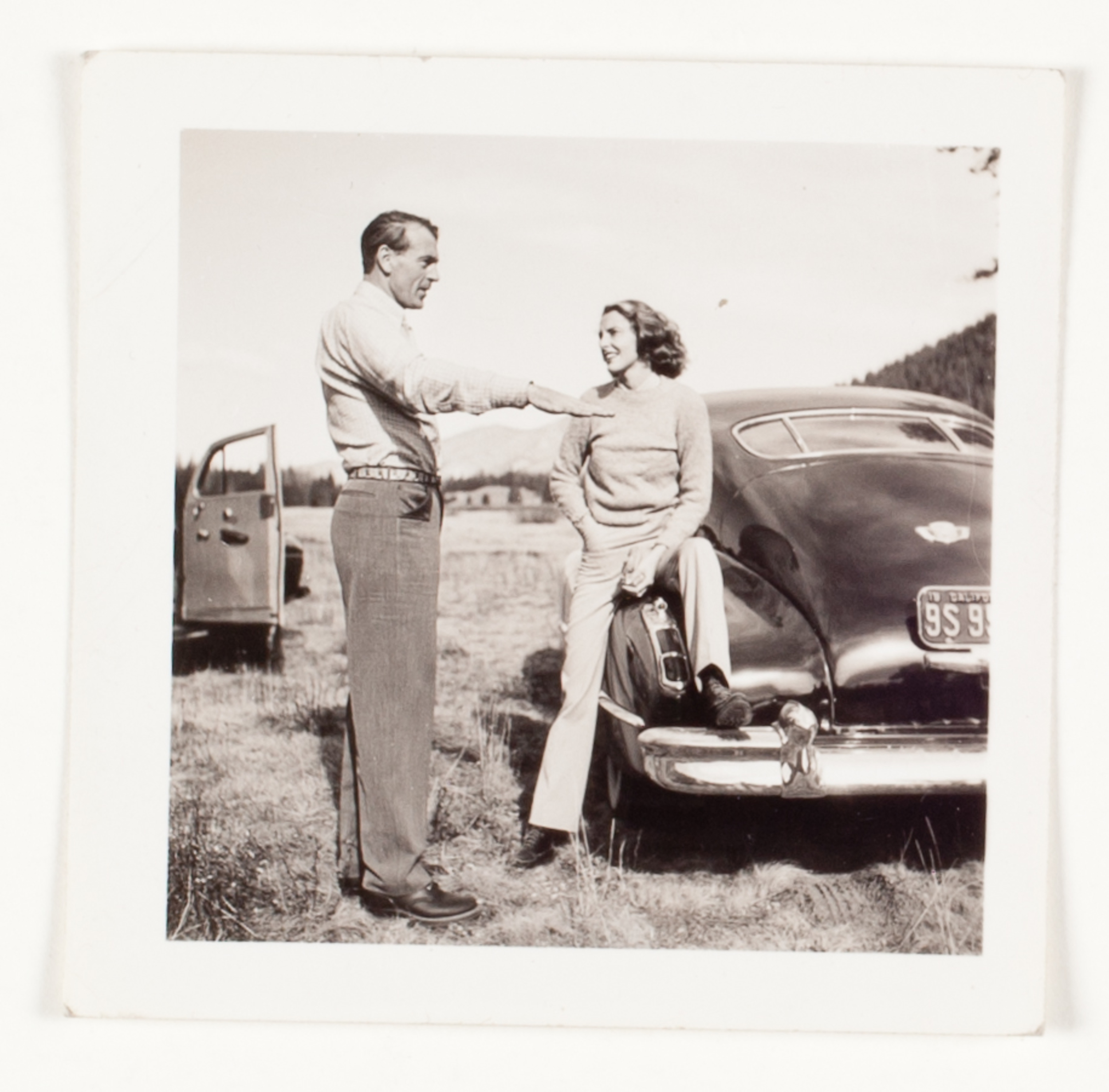 [Veronica Cooper sitting on a fender of car and speaking with Gary ...