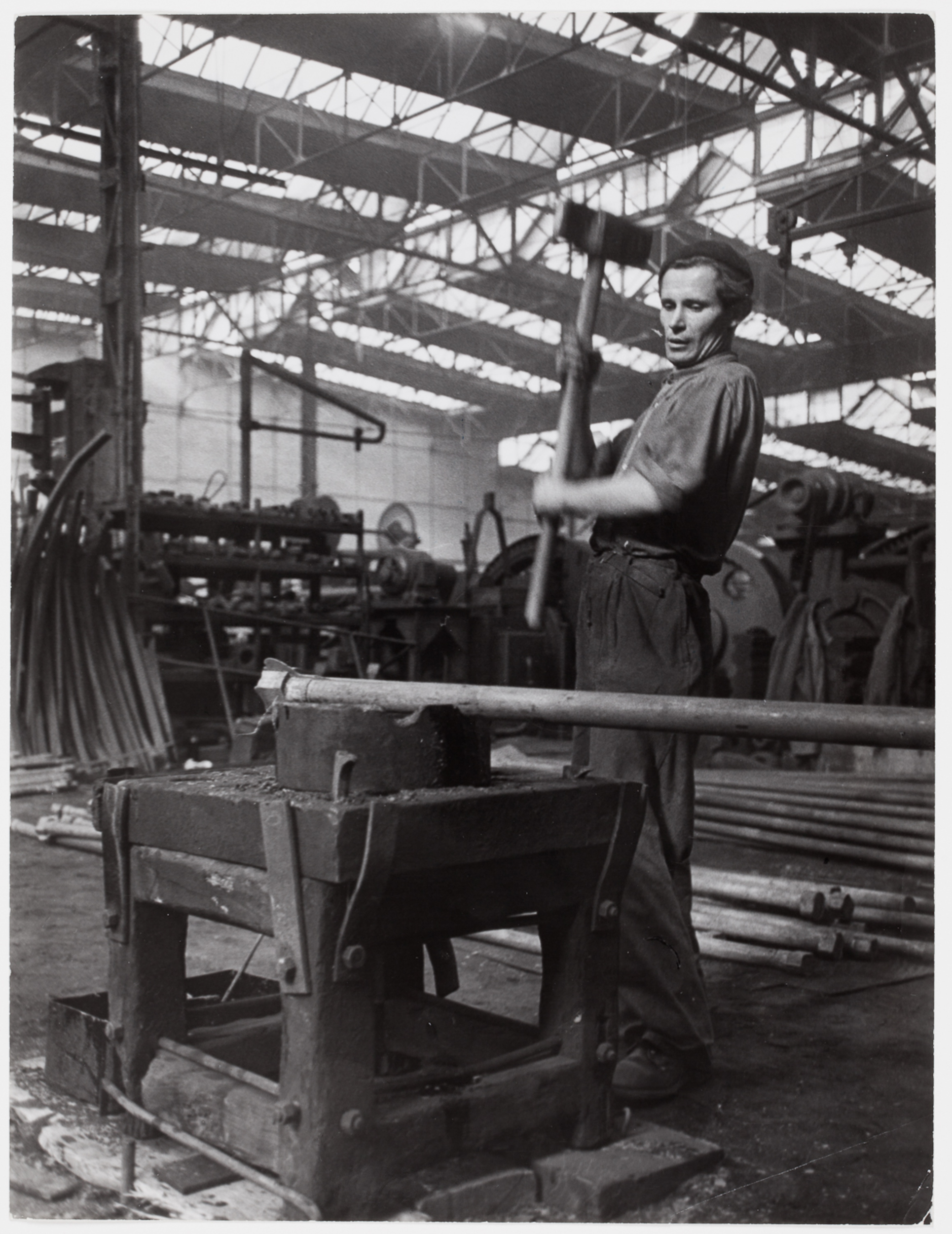 [Worker with hammer in railroad car factory, Wroclaw, Poland ...