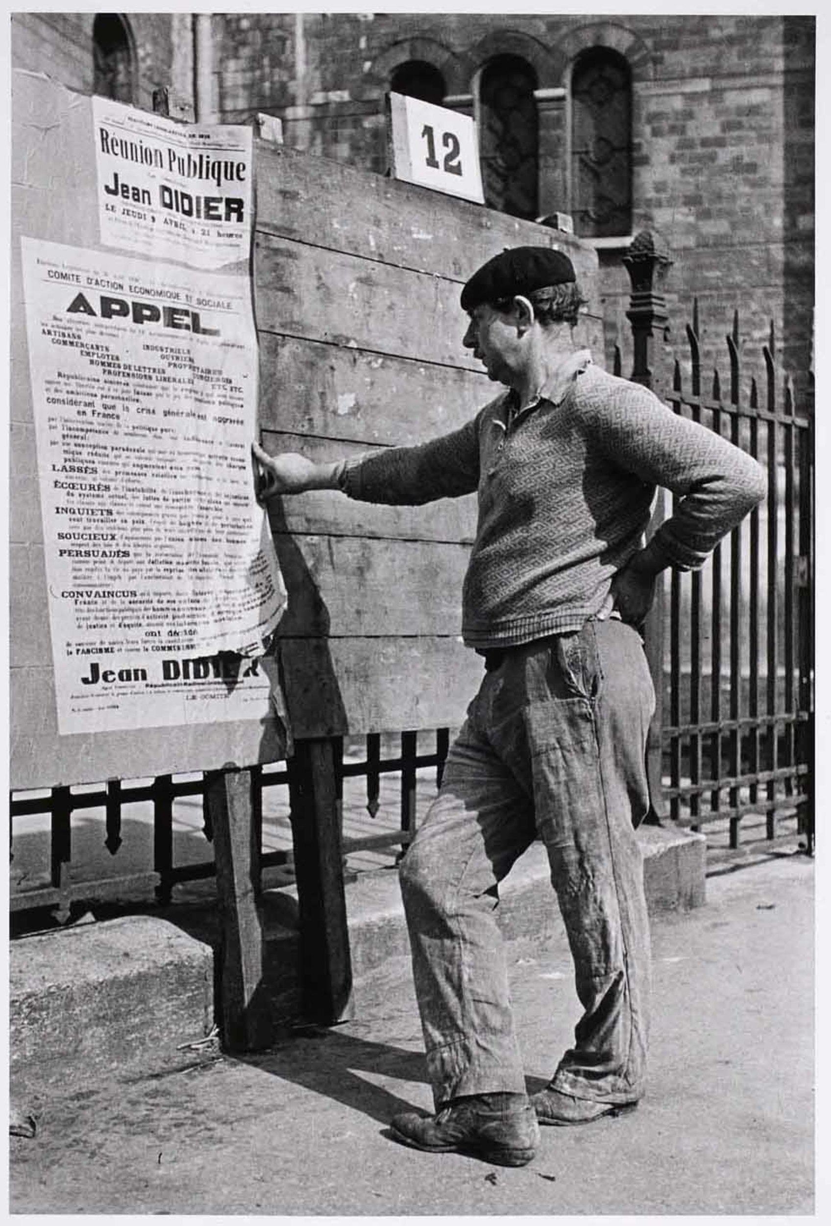 [Man looking at political poster before the national election that ...