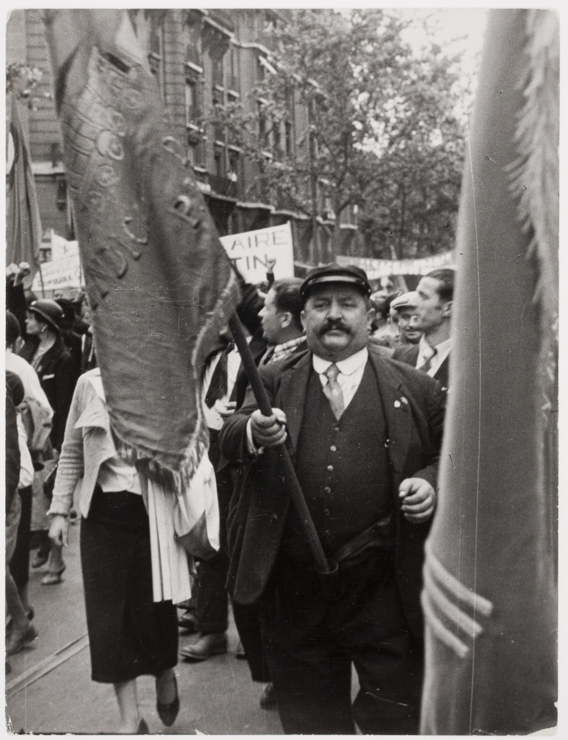 [Man holding a flag during May 1st Parade, Paris] | International ...