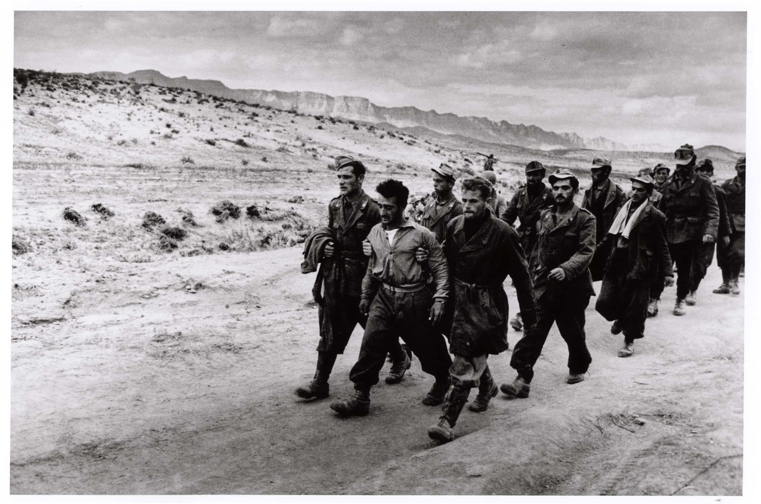 [Italian soldiers captured by American forces marching to a POW camp ...