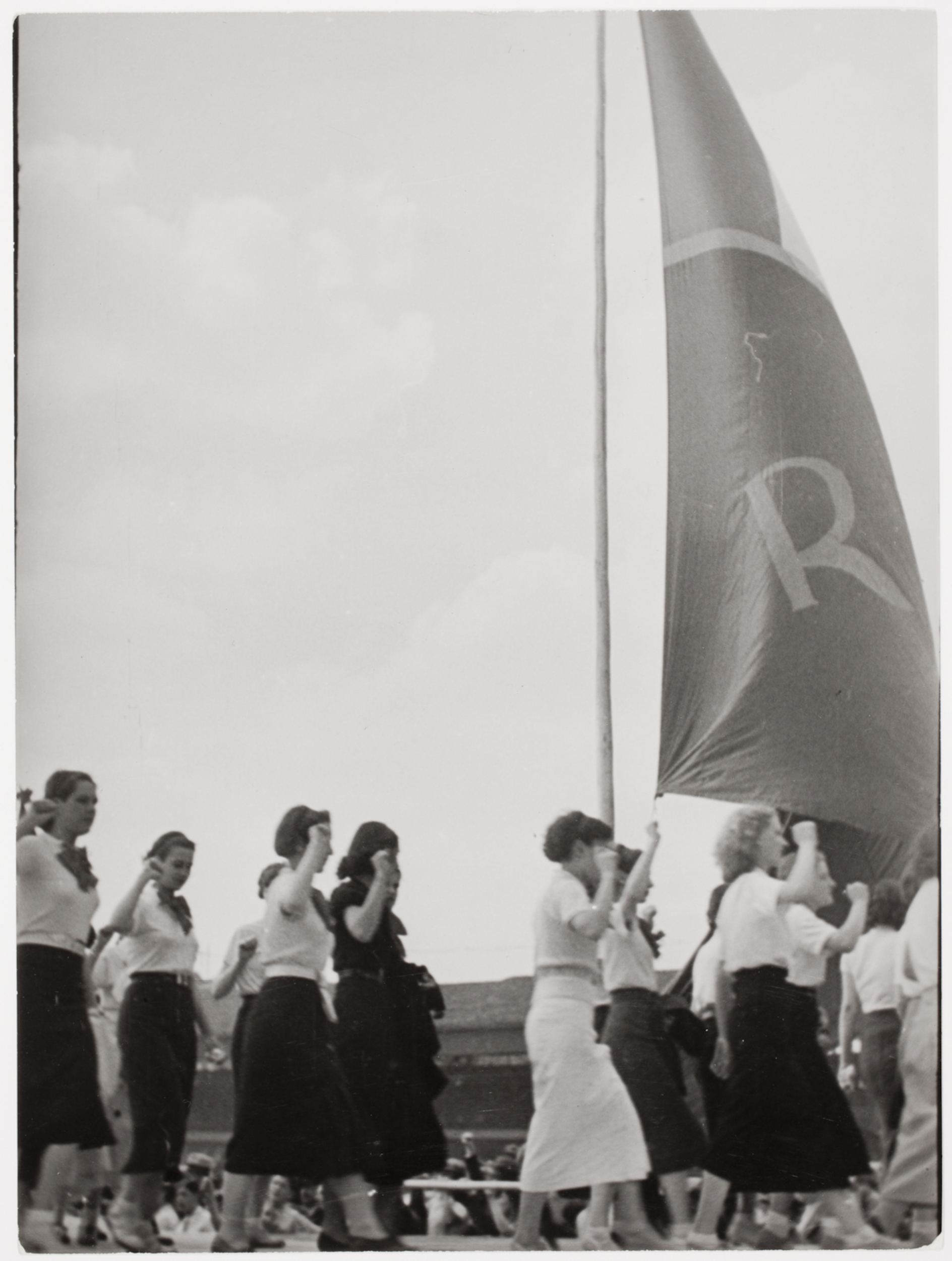 [Young women marching and saluting under the new flag of the French ...