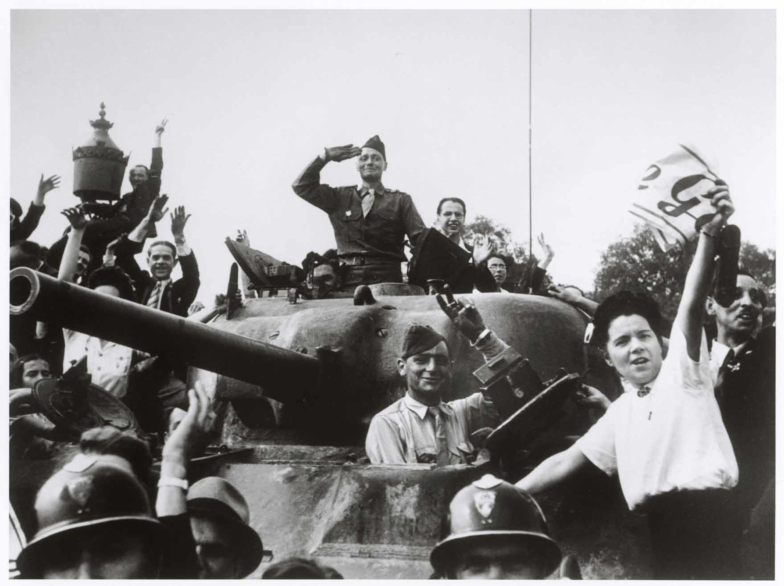 [Soldiers and civilians on a tank in the parade celebrating the ...