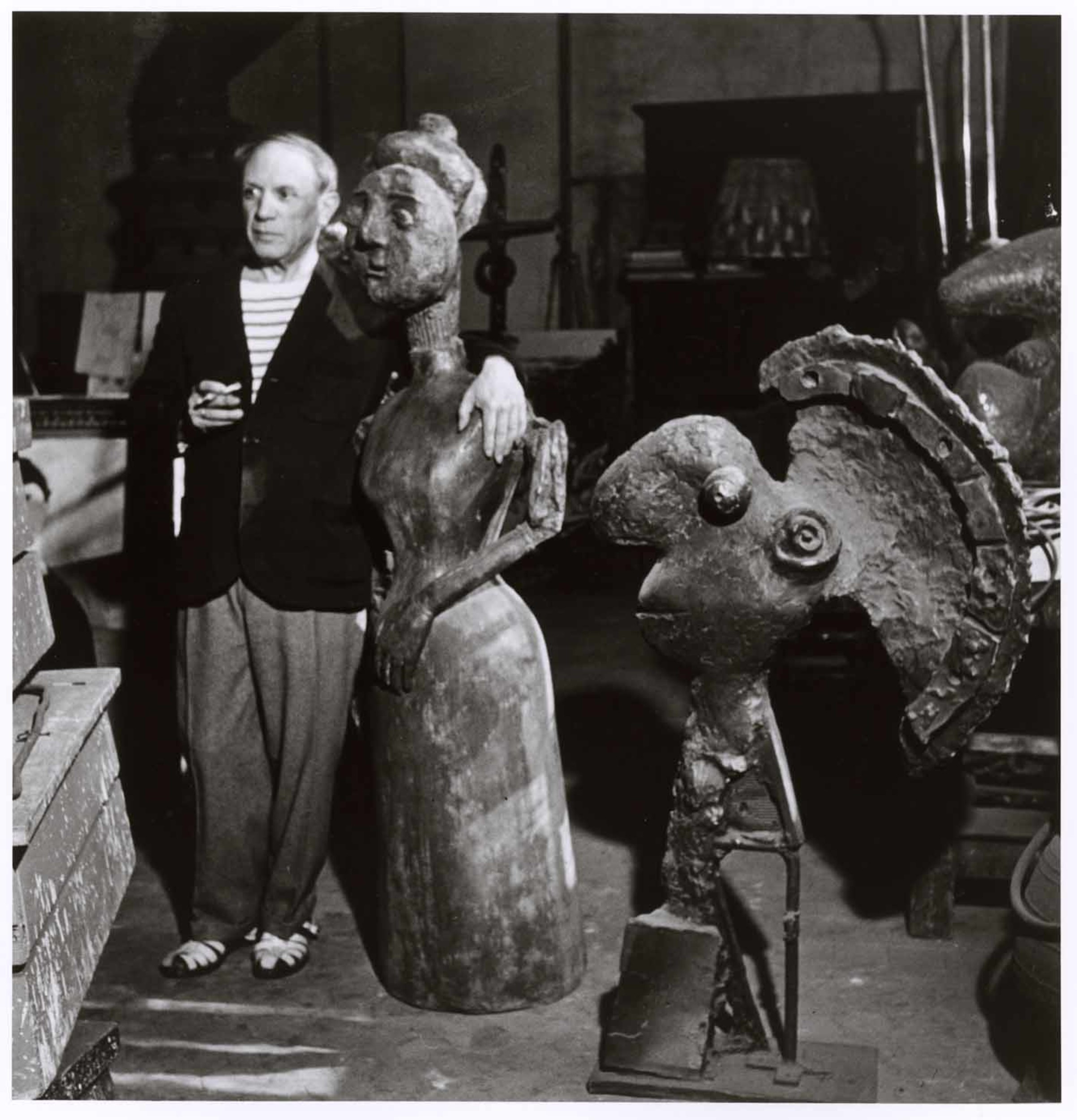 [Pablo Picasso standing next to one of his sculptures in his studio ...