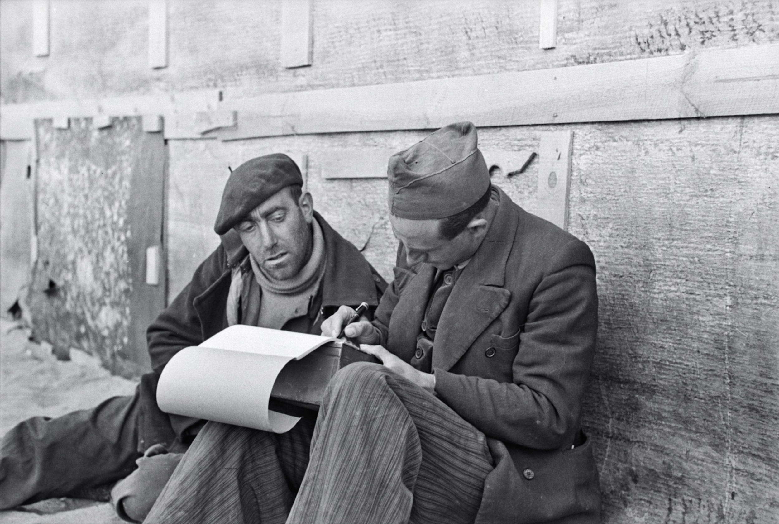 [Two men writing a letter at an internment camp for Spanish refugees ...
