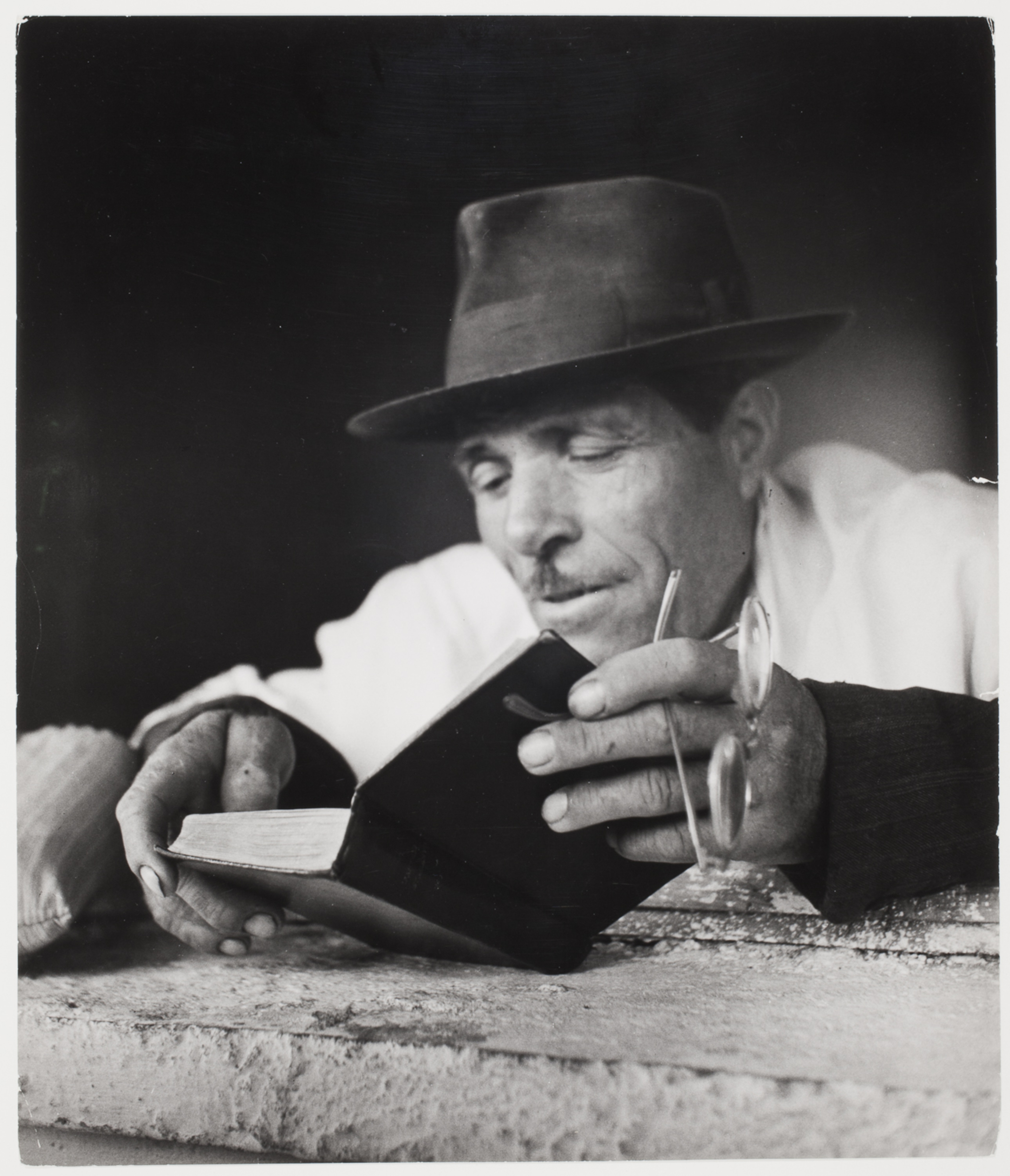 [Man with a hat reading a book, Israel] | International Center of ...
