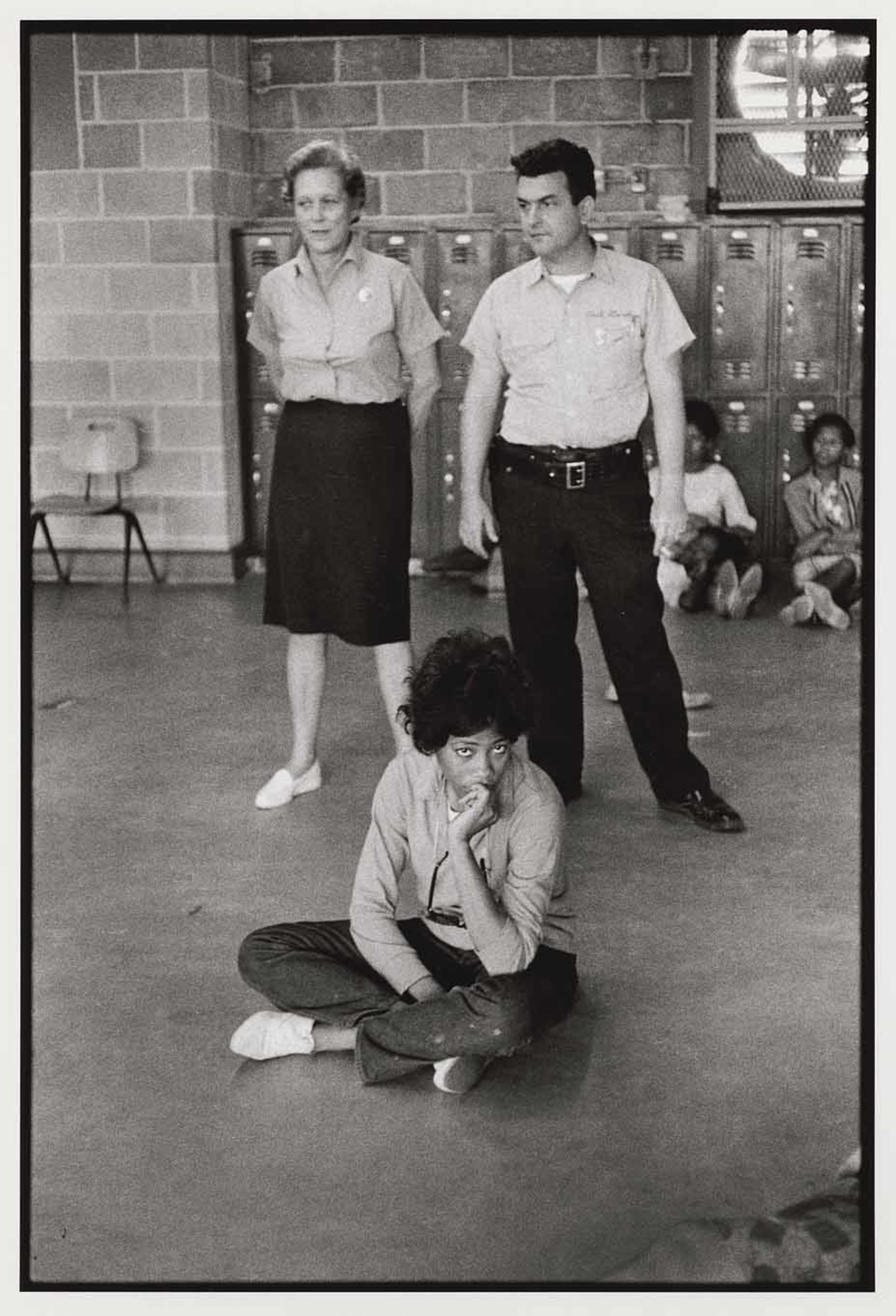 [A woman sits to protest racial discrimination in schools ...