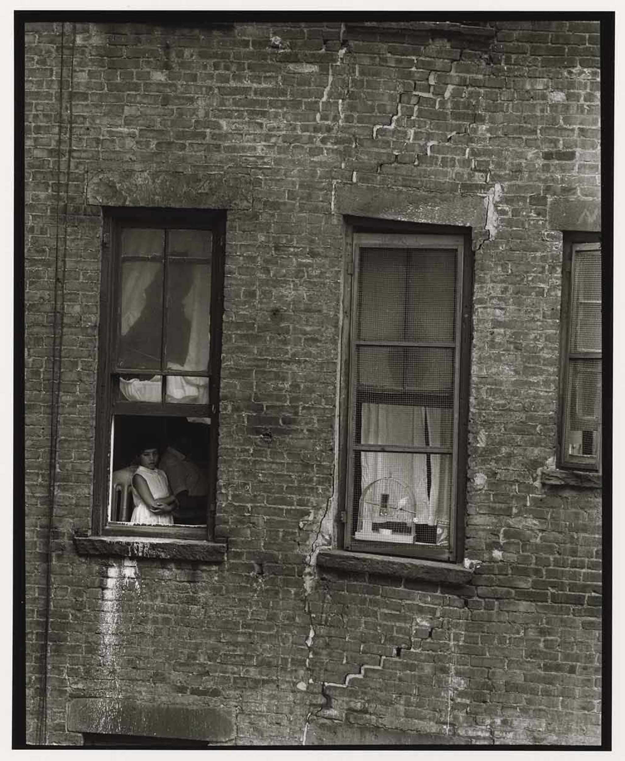 [Child gazes out window in brick facade] | International Center of ...