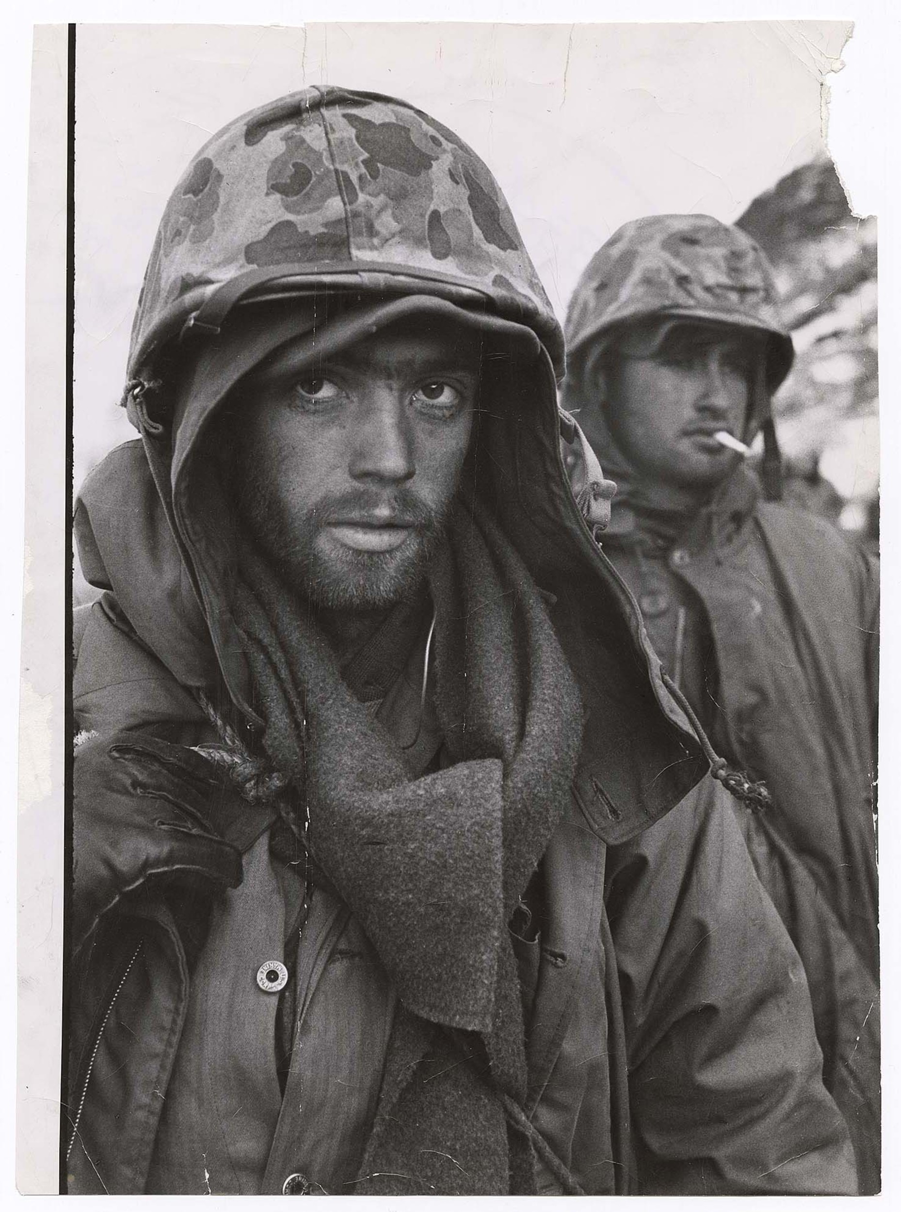 [Two American Marines, faces etched by fatigue, pause during their grim ...