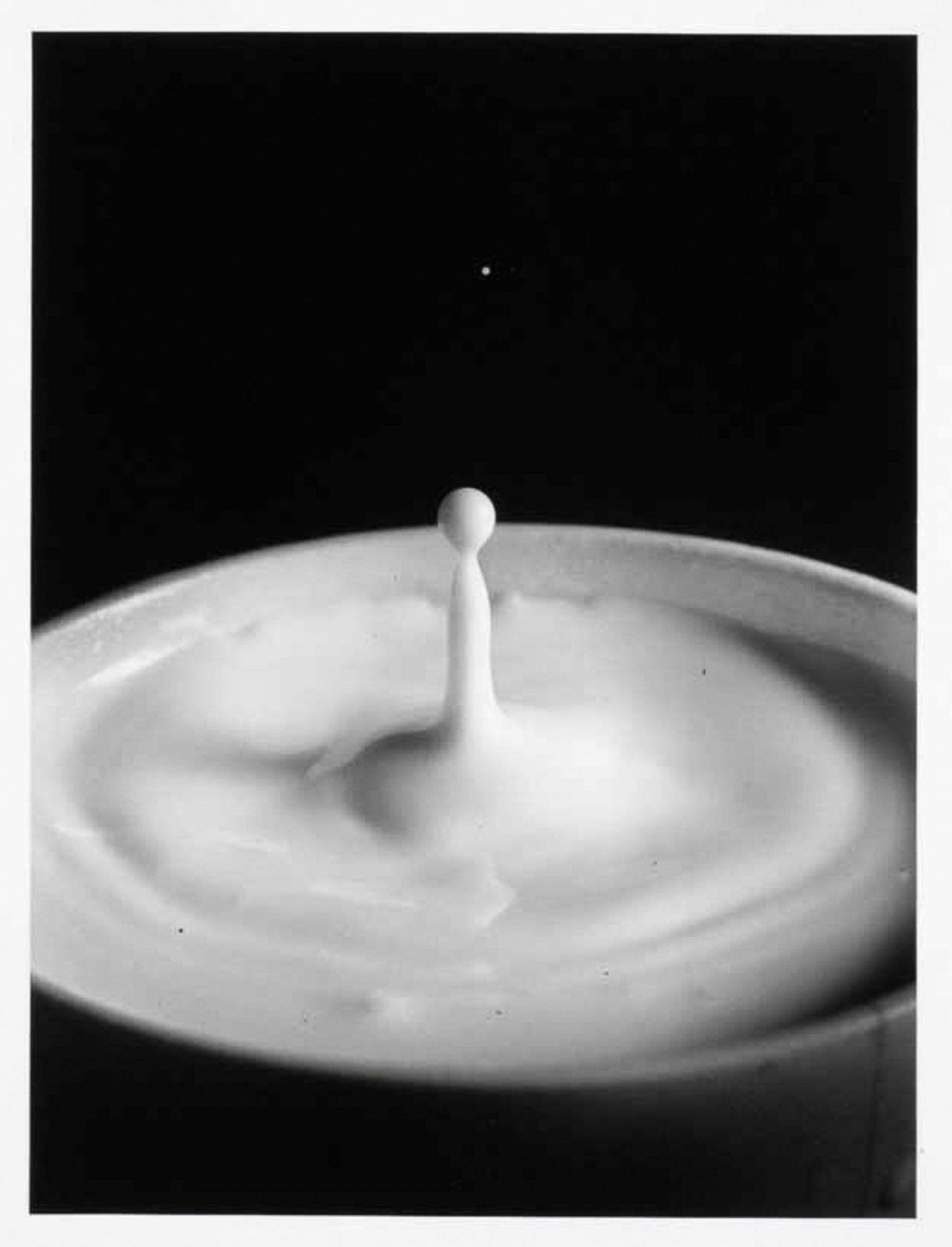 Drop falling into cup of milk | International Center of Photography