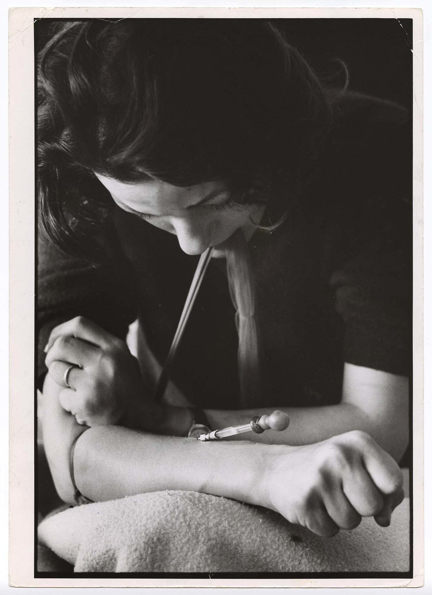 [Karen, a drug addict, using a hypodermic needle on an eyedropper or ...