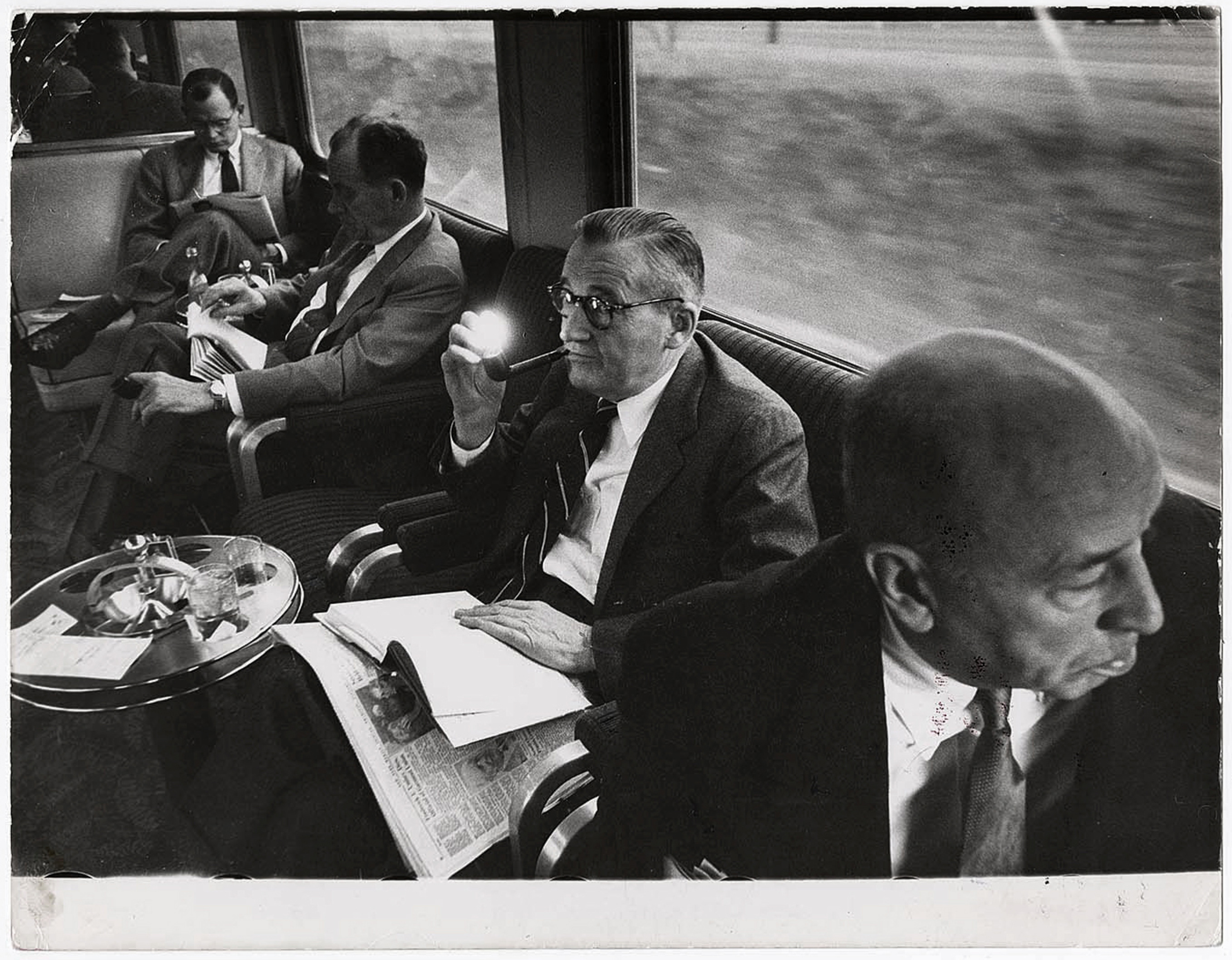 [Businessman smoking pipe as others read aboard the Pennsylvania's ...