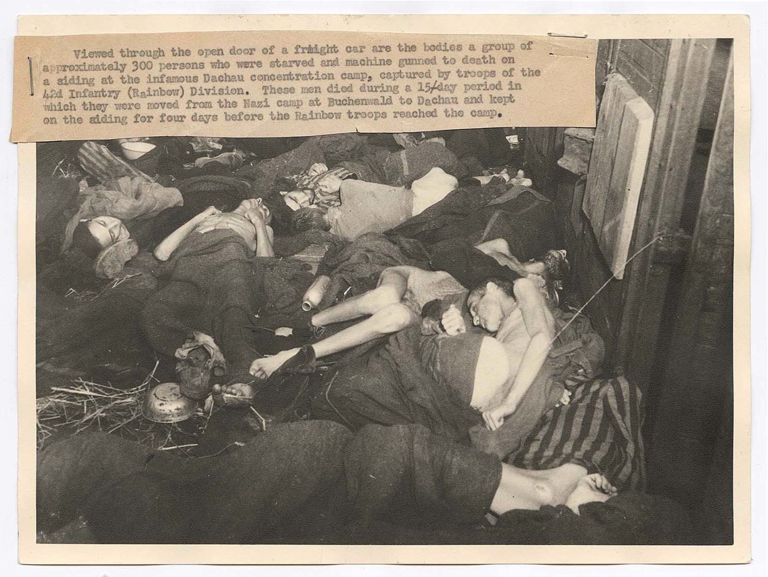 Viewed through the open door of a freight car are the bodies of ...