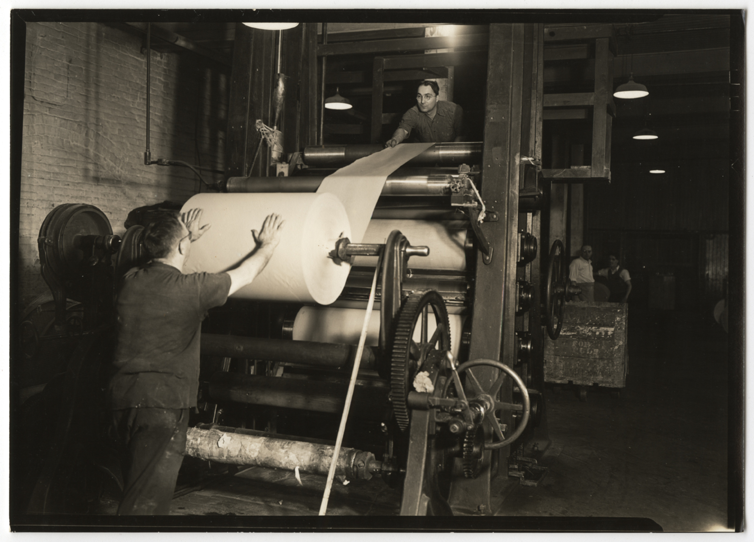 [Worker rewinding paper from reel to make matchboard, American Writing ...