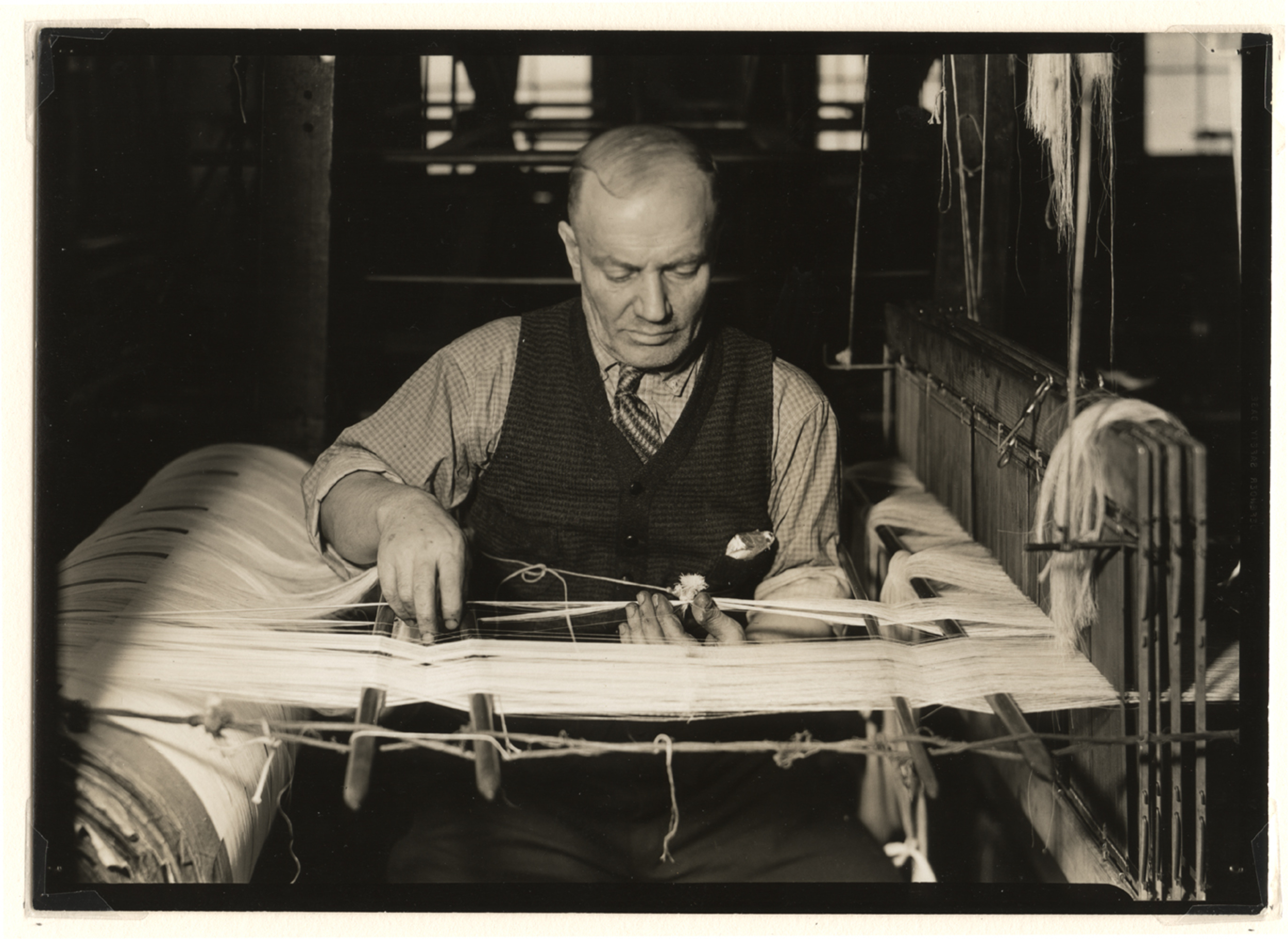 [Worker twisting warp ends on to "from" ends, Paterson, New Jersey ...