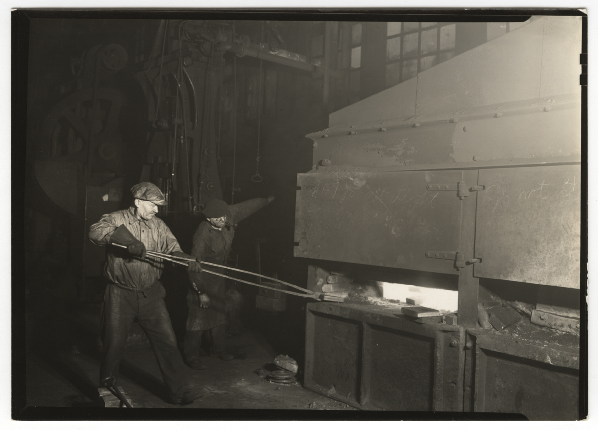 [Blacksmith and helper working on modern forge in smith's shop, Baldwin ...
