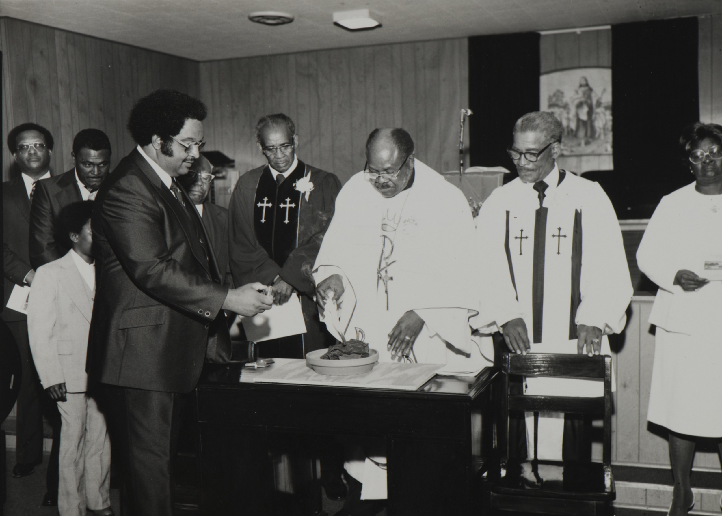 [Men, women, and children gathering with clergy in church ...