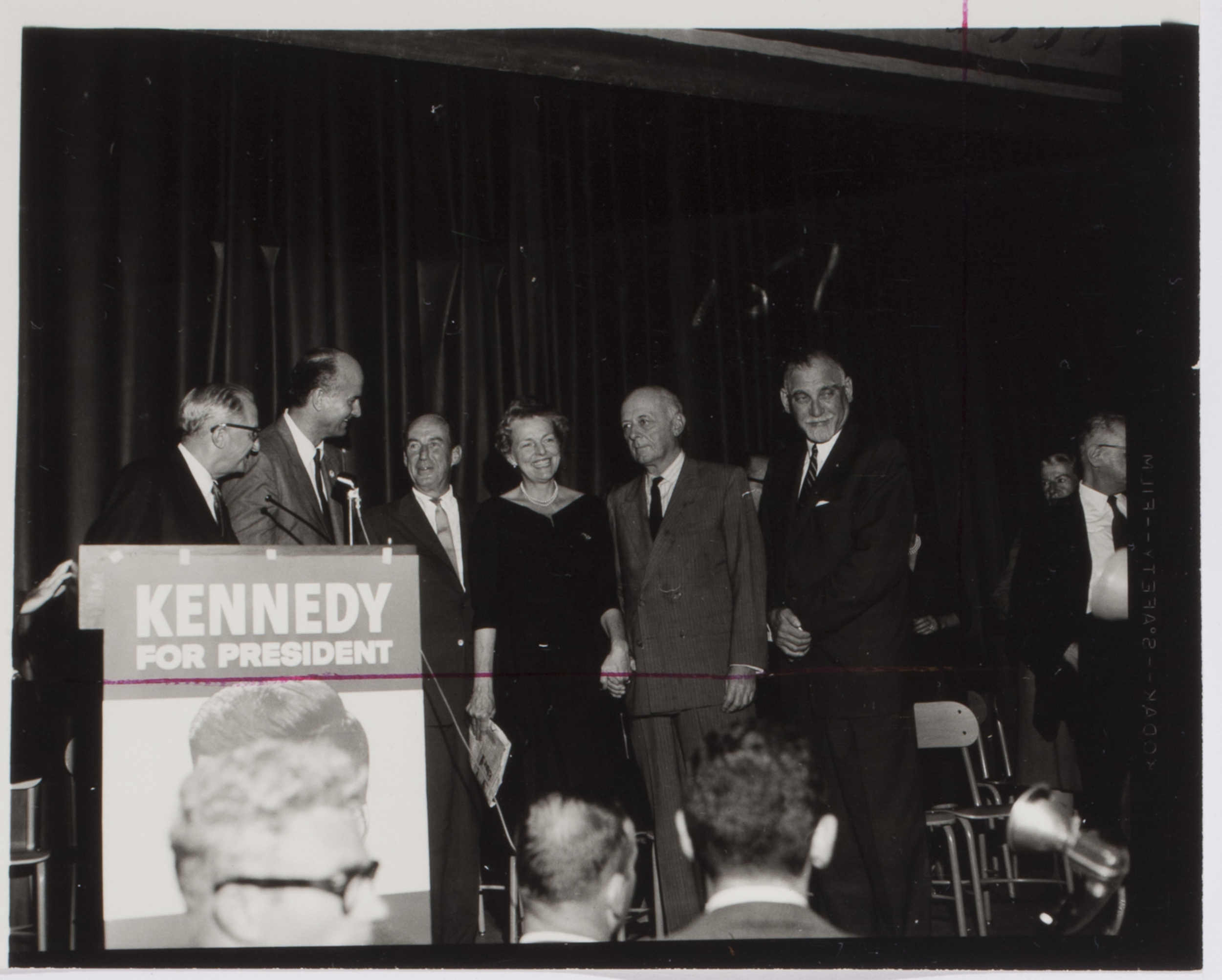 [Adlai Stevenson standing onstage with men and women during John F ...